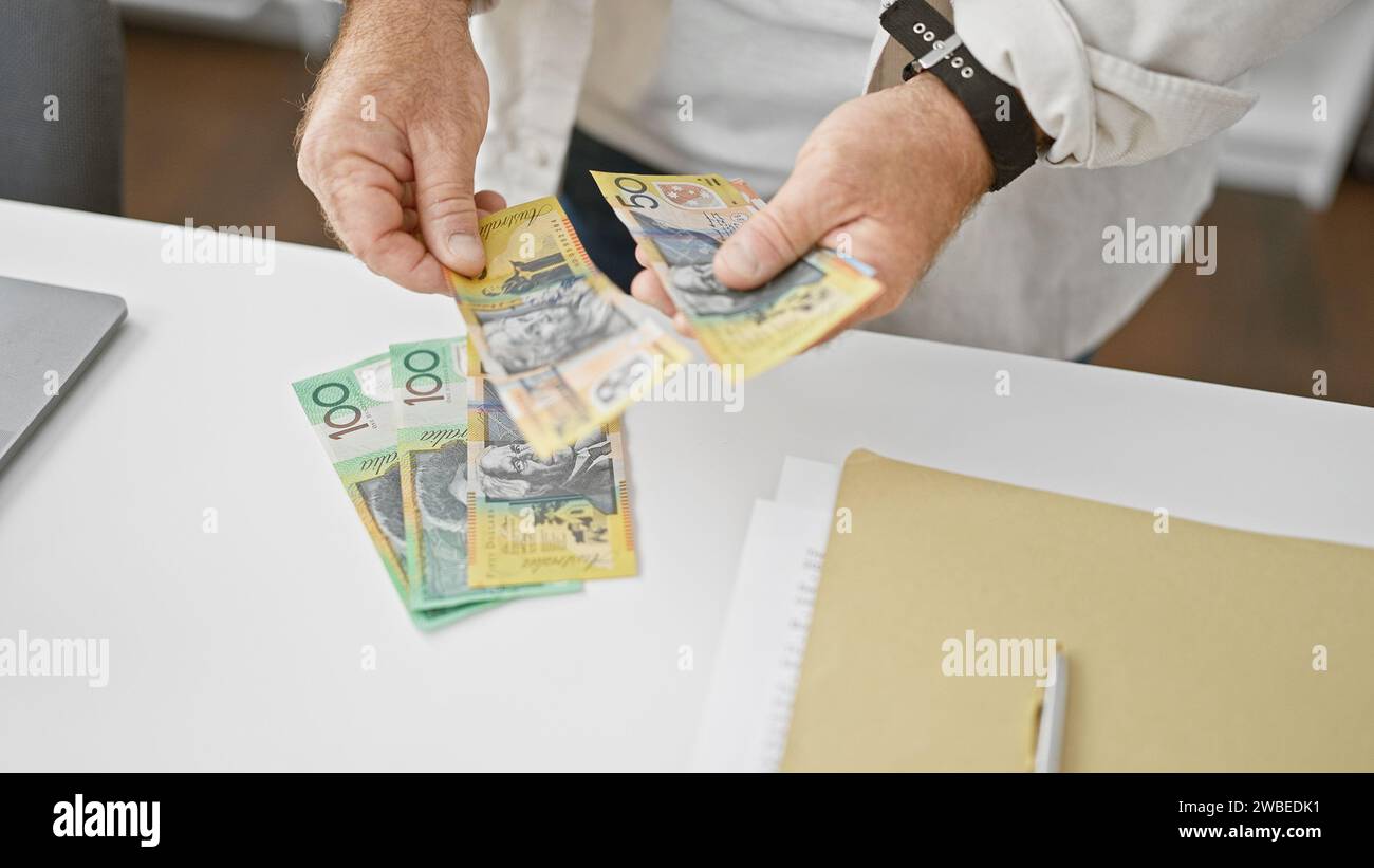 Handsome middle-aged caucasian business man counting stacks of ...