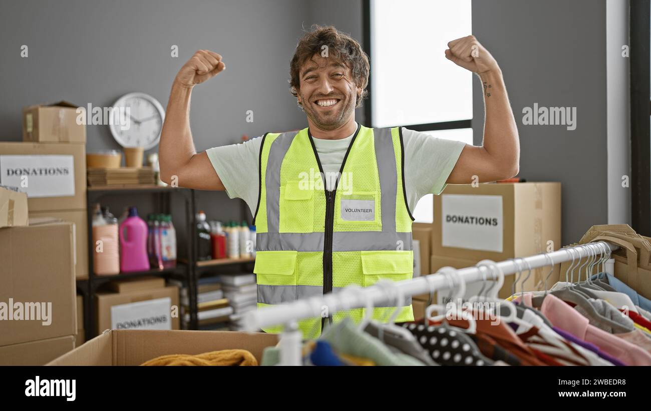 A cheerful man flexes his muscles proudly in a donation center filled ...