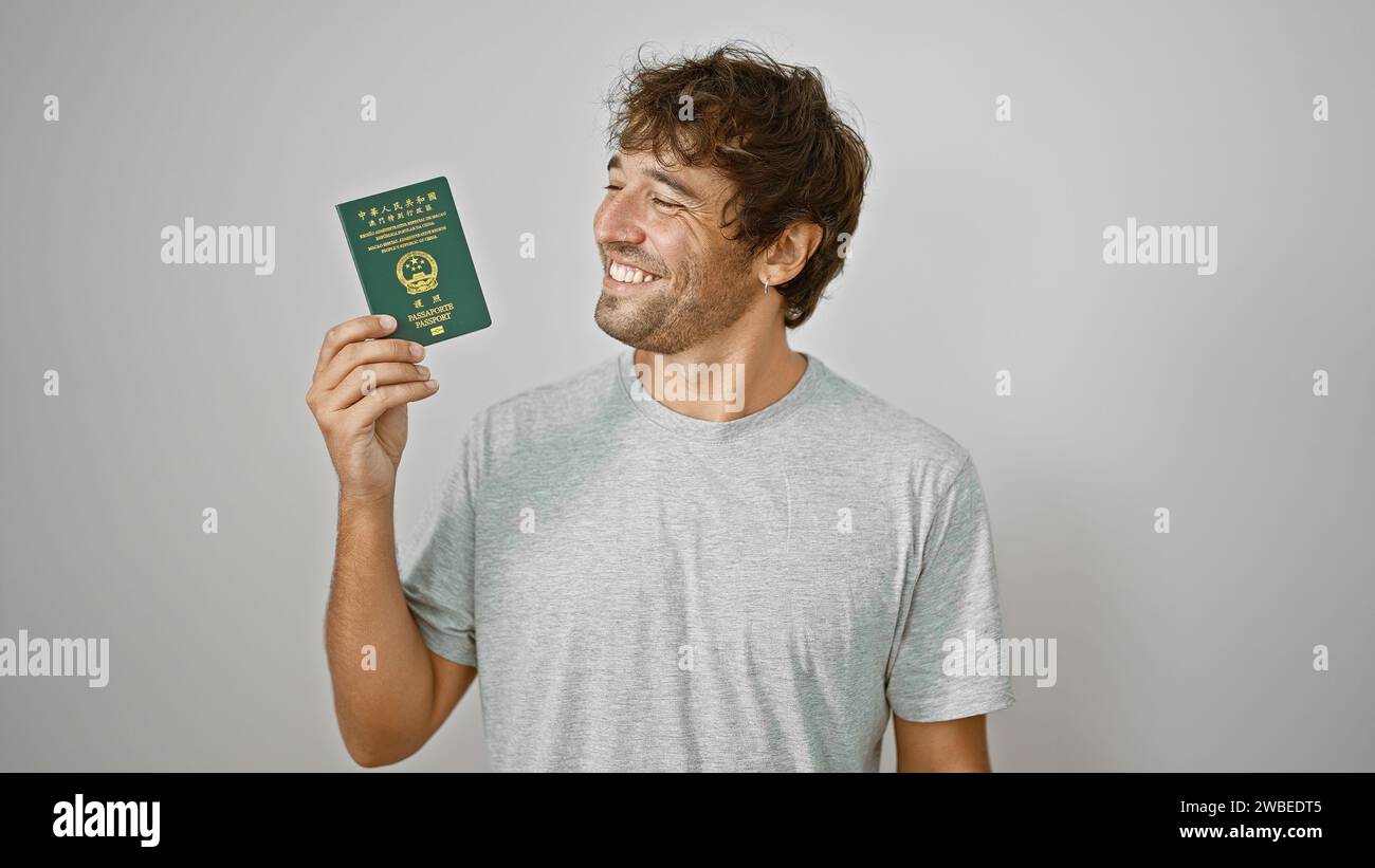 Beaming young man ecstatically waving his macao passport, soaking up ...