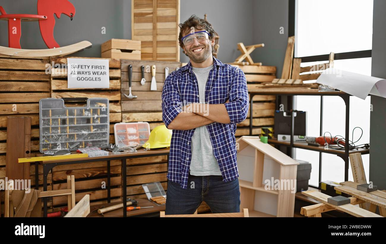 Portrait of a smiling young man carpenter, striking a confident pose ...