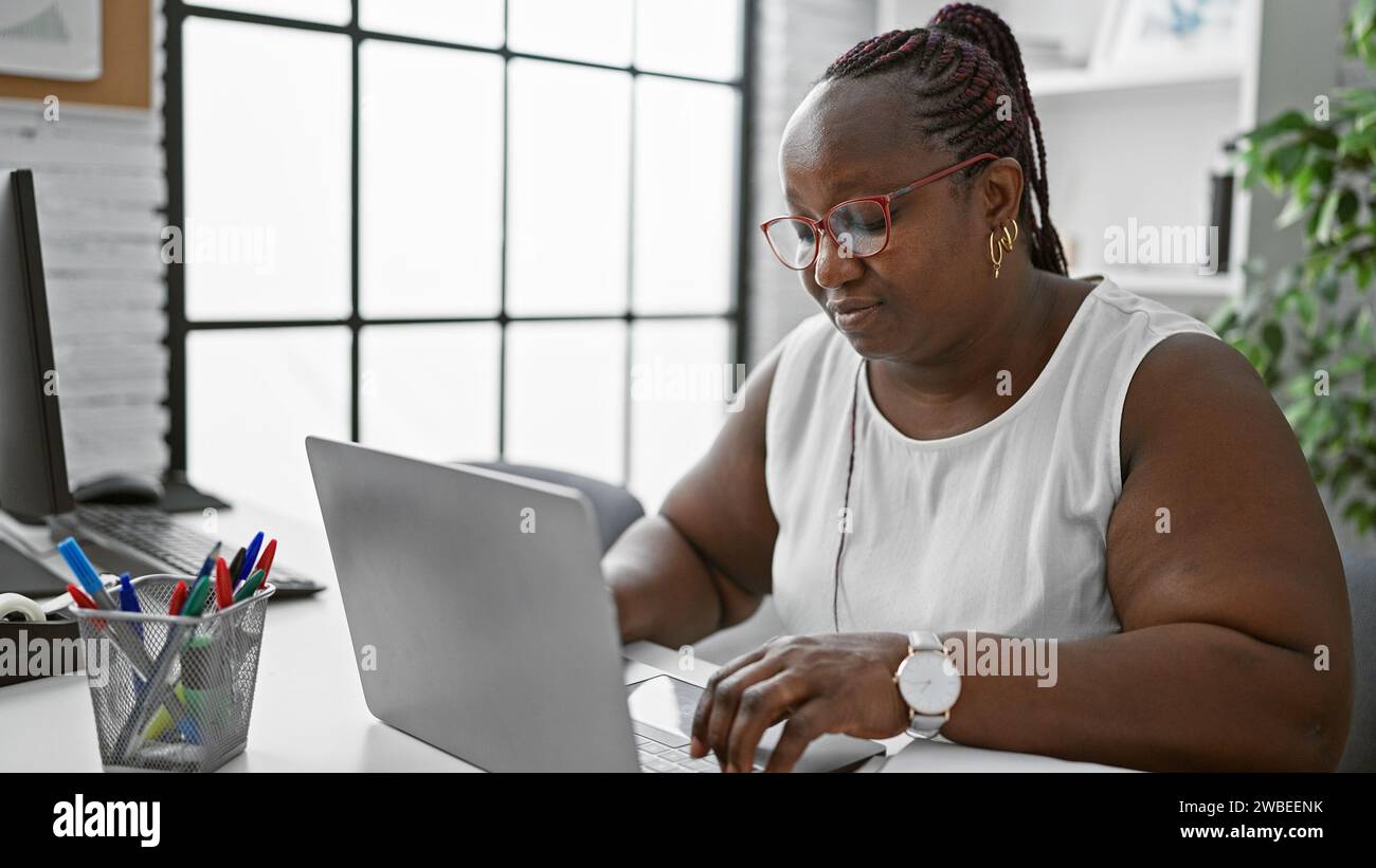 Focused african american woman worker excelling in business. working ...