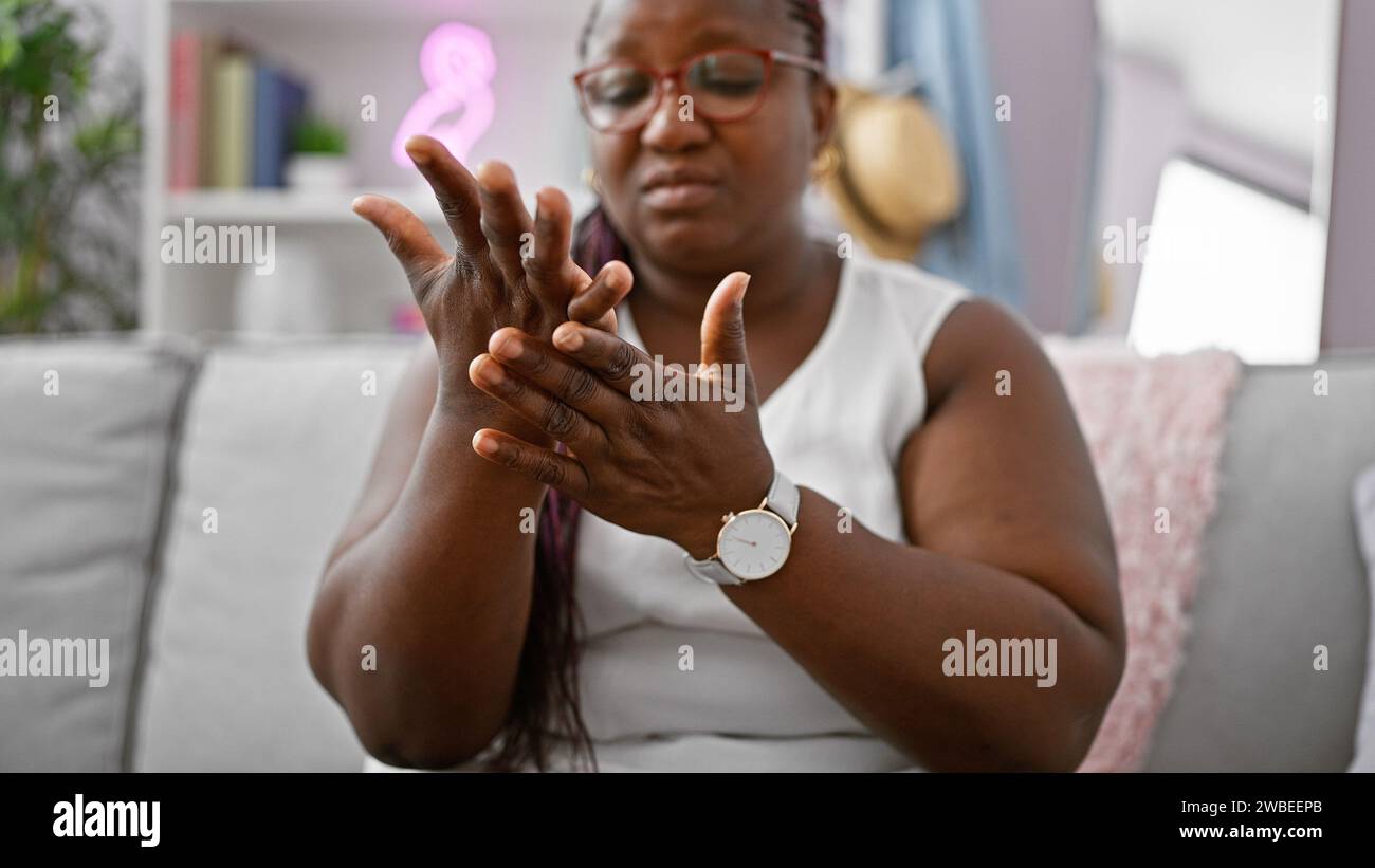 African american woman, unhappy in her cozy living room, sitting on the ...