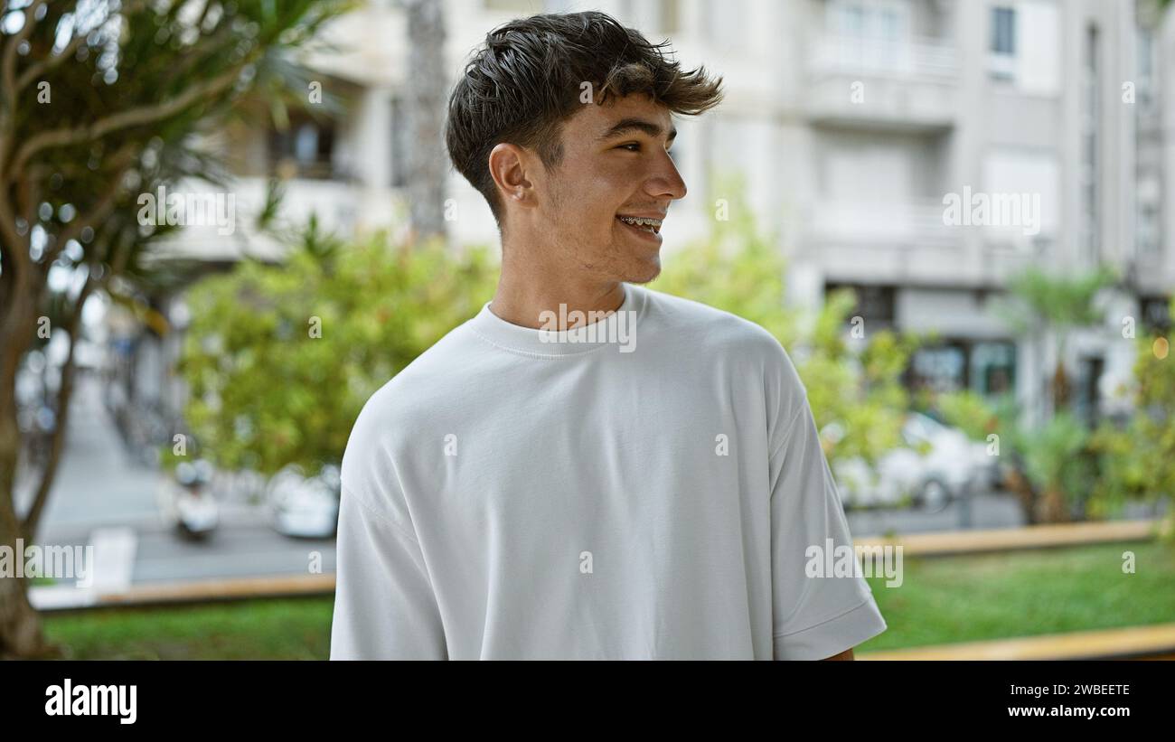 Cheerful young hispanic teenager radiates confidence, joyfully smiling ...