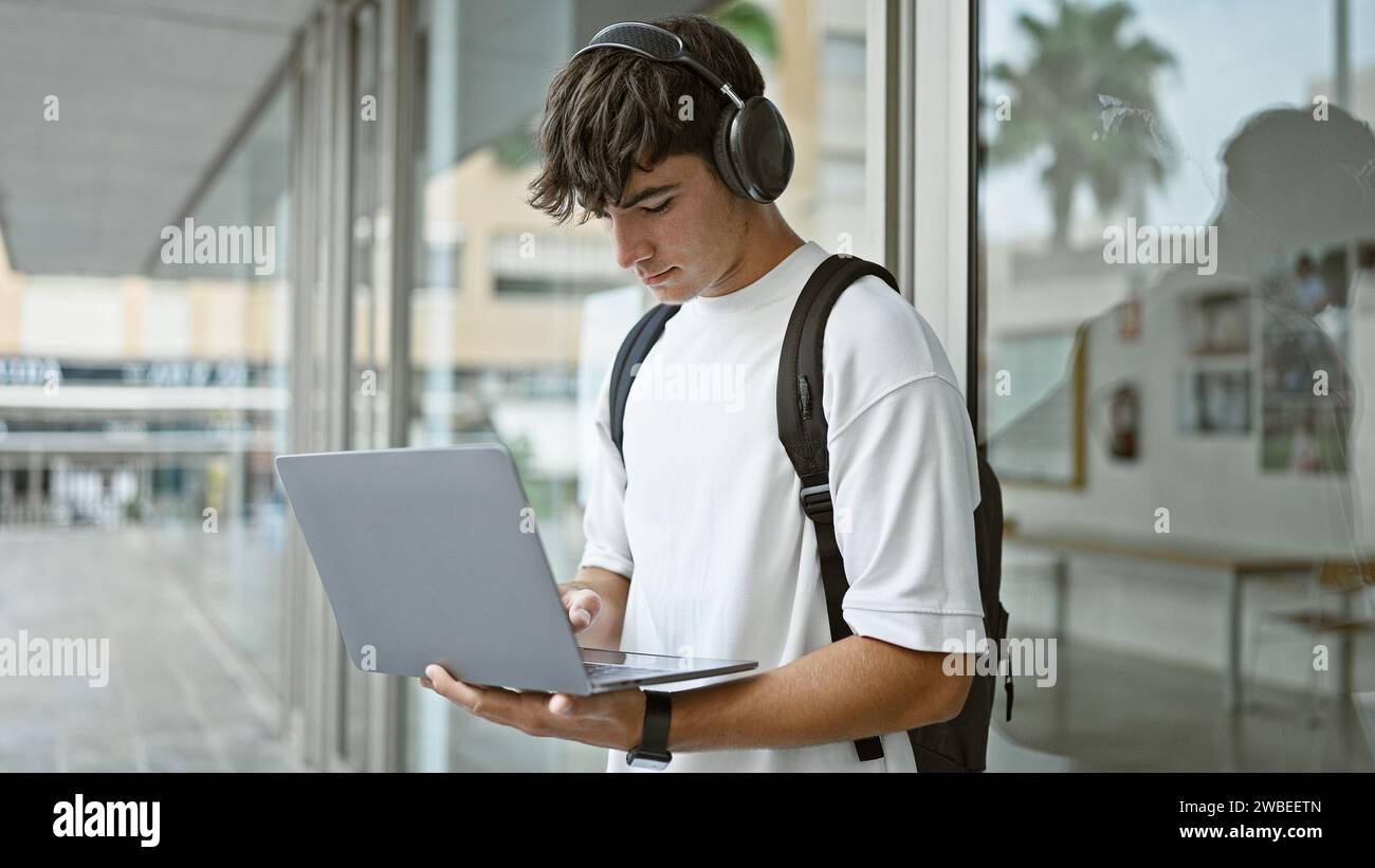 Cool young hispanic dude, a smart university student, lost in music ...