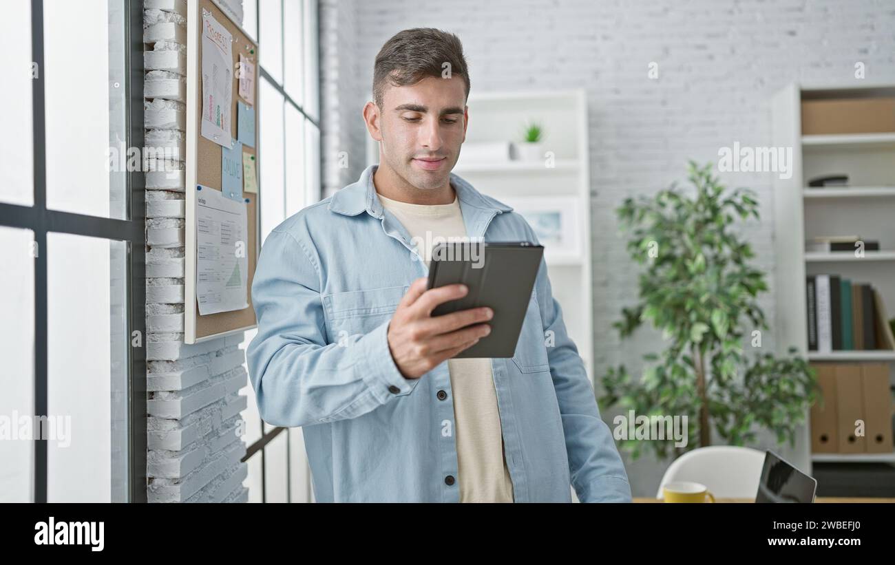 Handsome young hispanic man concentrating at work, successful business ...