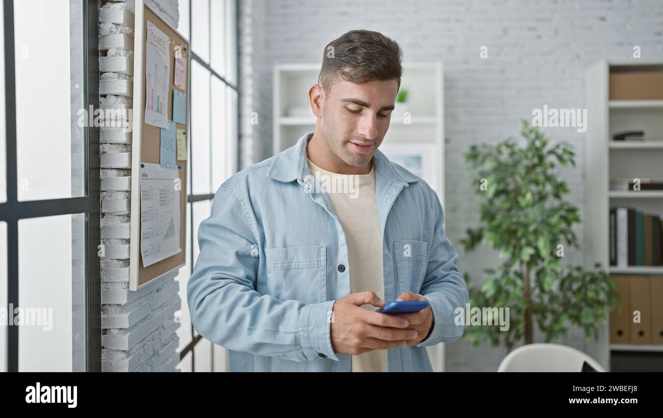 Handsome young hispanic man, a real go-getter, totally absorbed in work ...