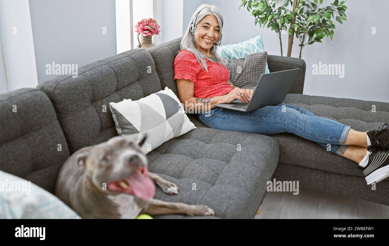 Chilled-out grey-haired woman enjoying cosy online catch-up with ...