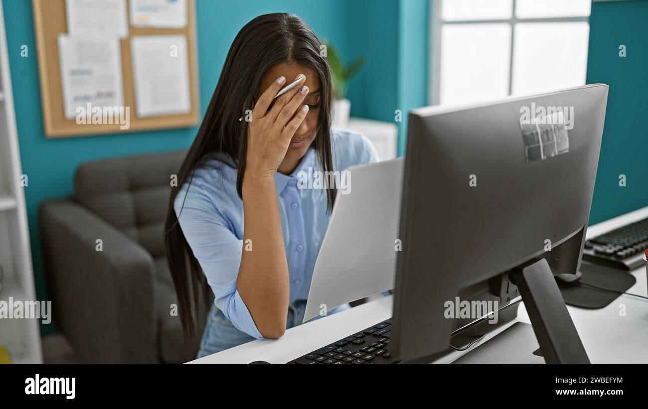 Young latin woman business worker using computer reading document ...