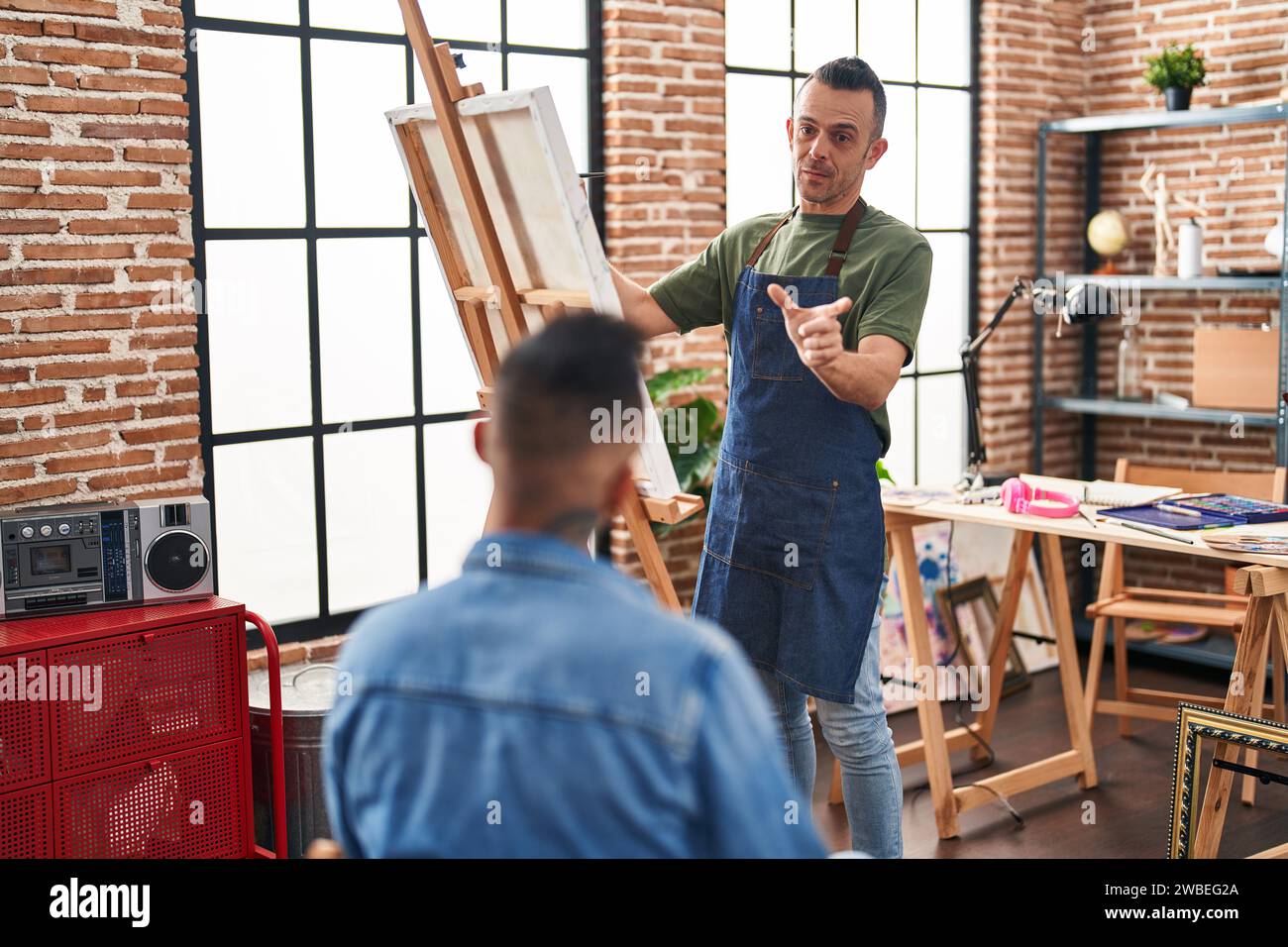 Two men artists drawing portrait at art studio Stock Photo - Alamy
