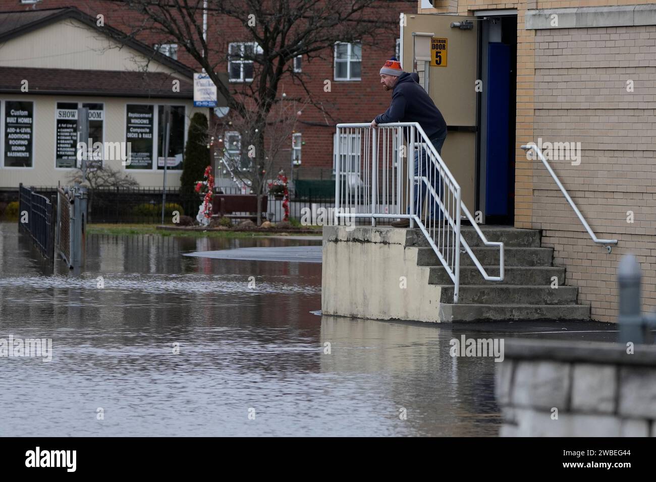 A man looks over a flooded street in Lodi, N.J., Wednesday, Jan. 10 ...