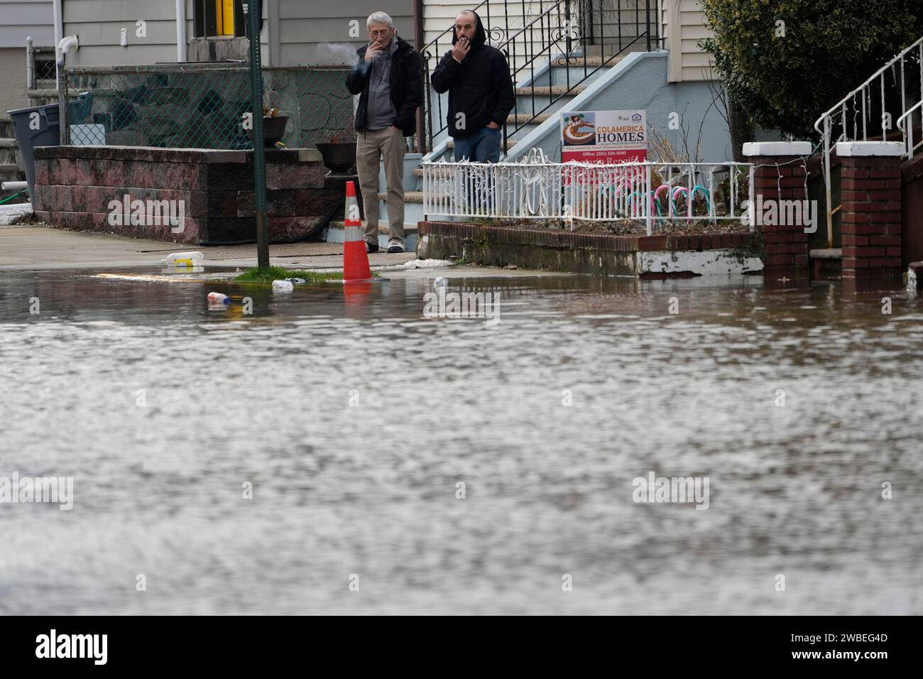 Men looks over a flooded street in Lodi, N.J., Wednesday, Jan. 10, 2024 ...