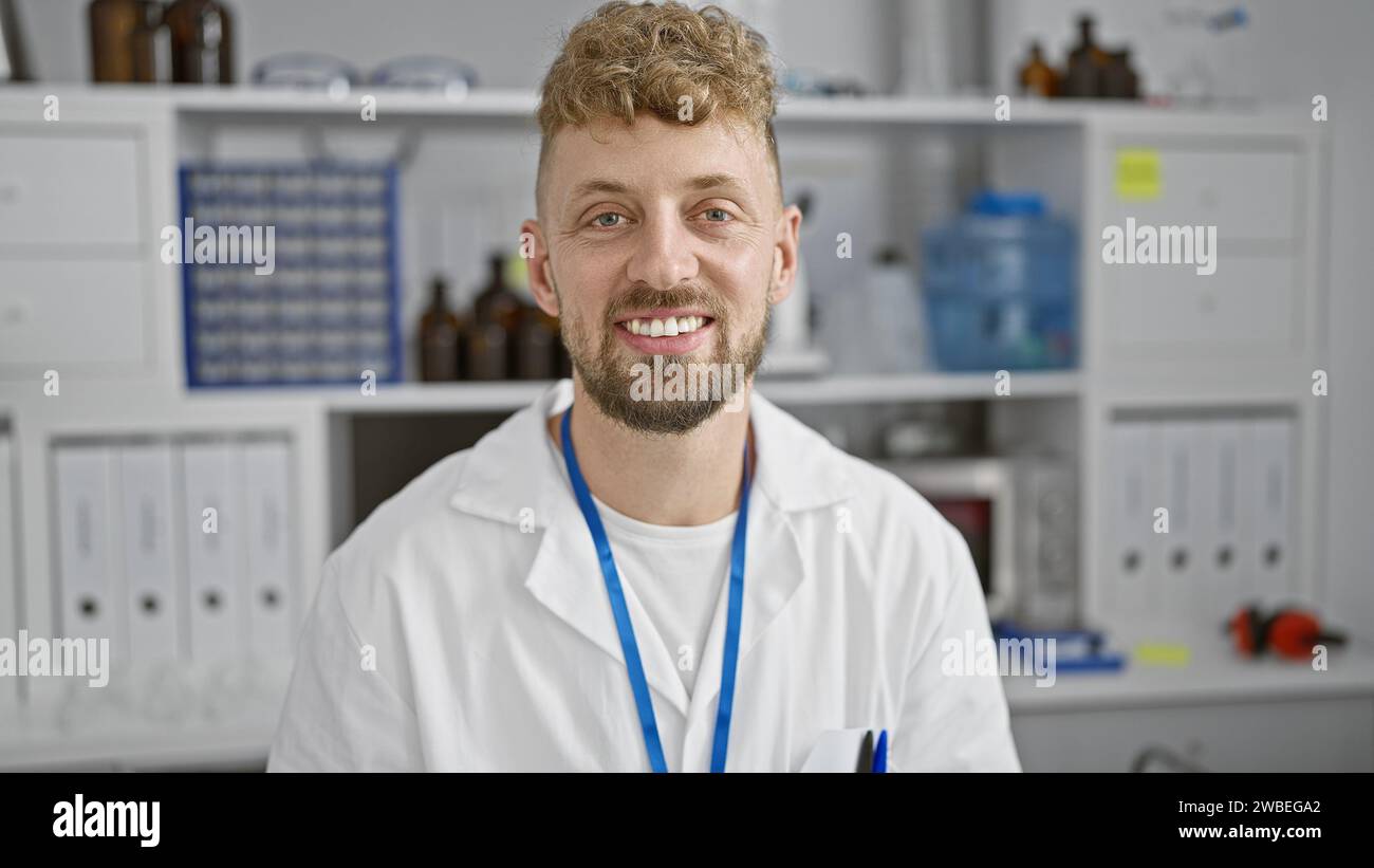 Caucasian man with blue eyes and beard smiling in white lab coat inside laboratory Stock Photo ...