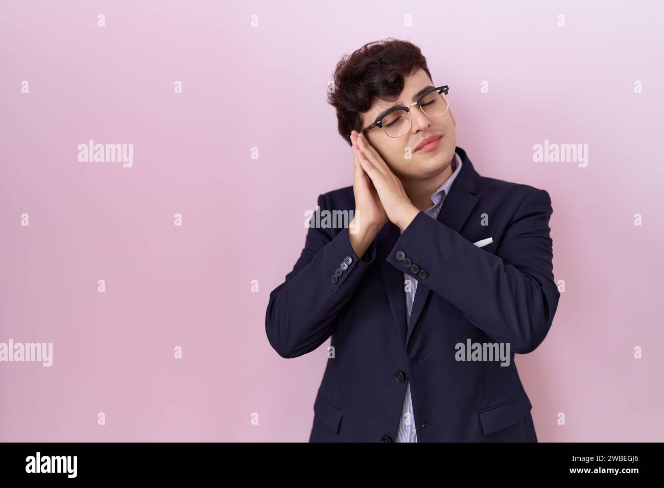 Young non binary man with beard wearing suit and tie sleeping tired ...