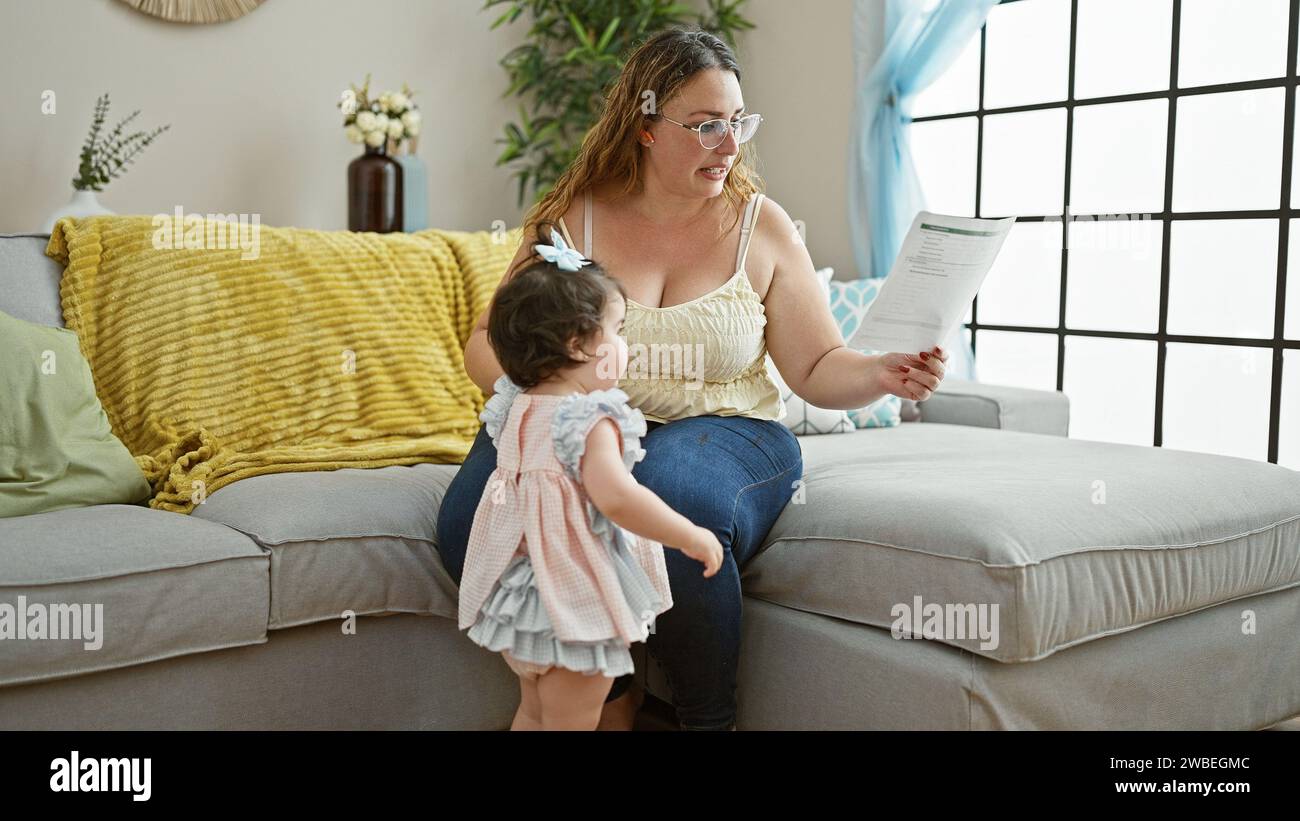 Casual, relaxed mother and daughter lovingly reading an important ...