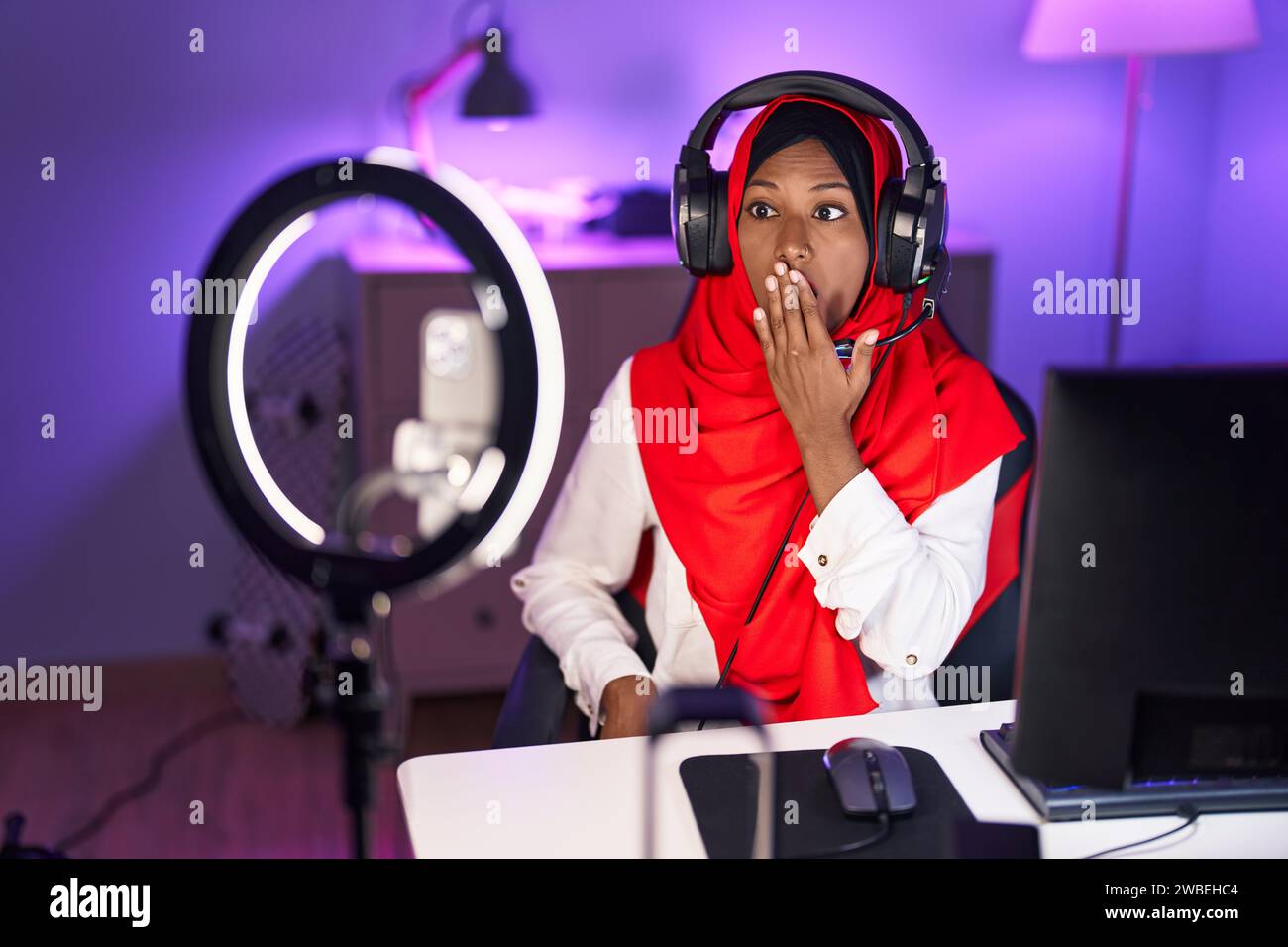 Young indian woman playing video games recording with smartphone ...