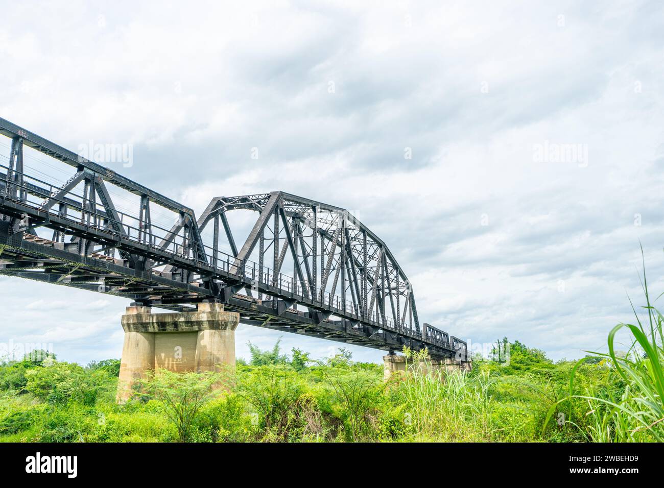 Beautiful scenic of black steel railway bridge across the river (Pasak river) in Lop Buri ...