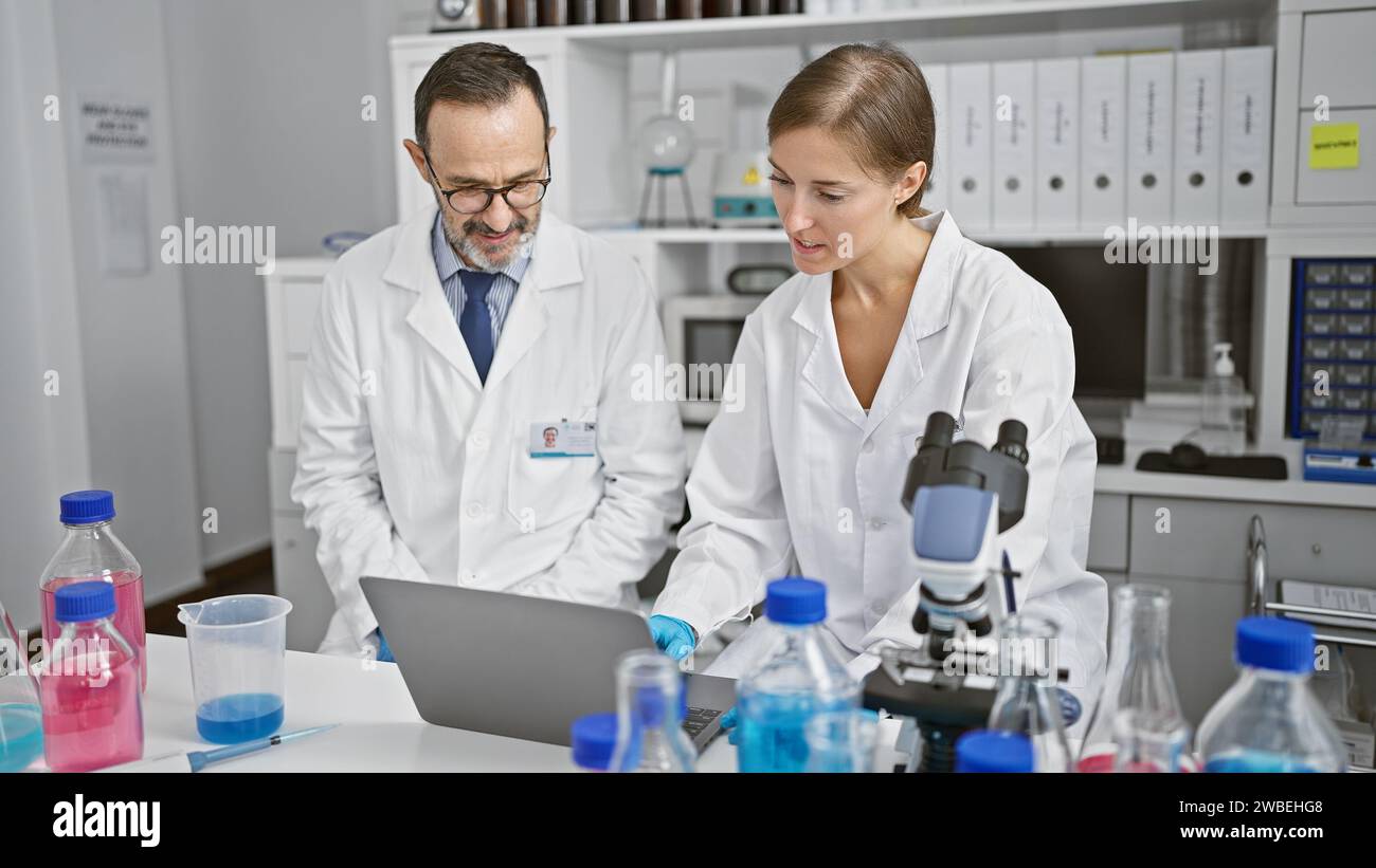 Two serious scientists in glasses, engrossed in a vital research ...