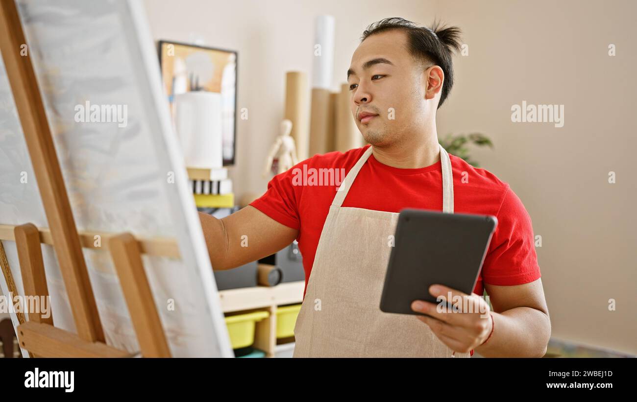 Handsome young chinese man, a passionate artist, intensely concentrated ...