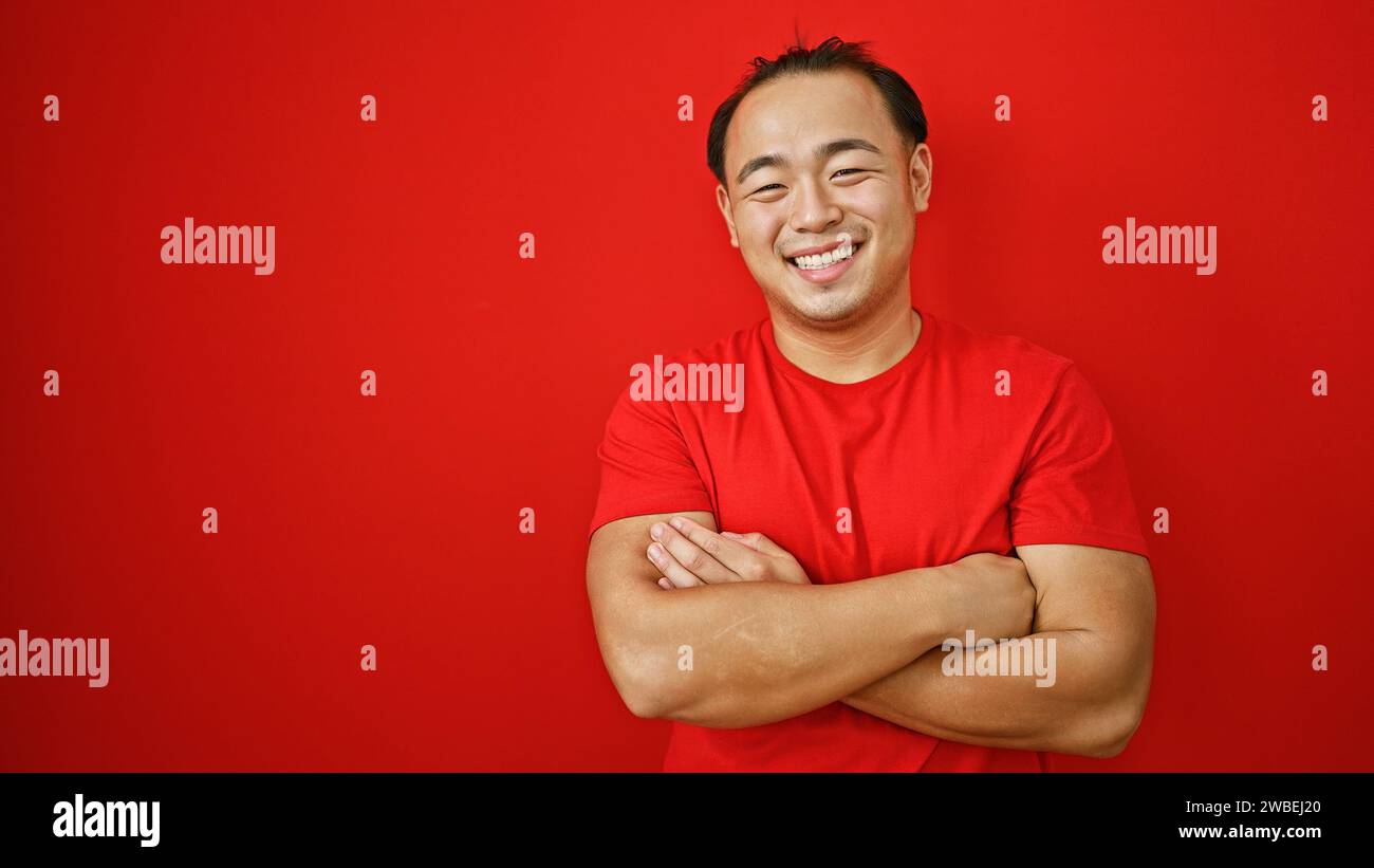 Laughing handsome young asian man exudes confidence, standing with arms ...
