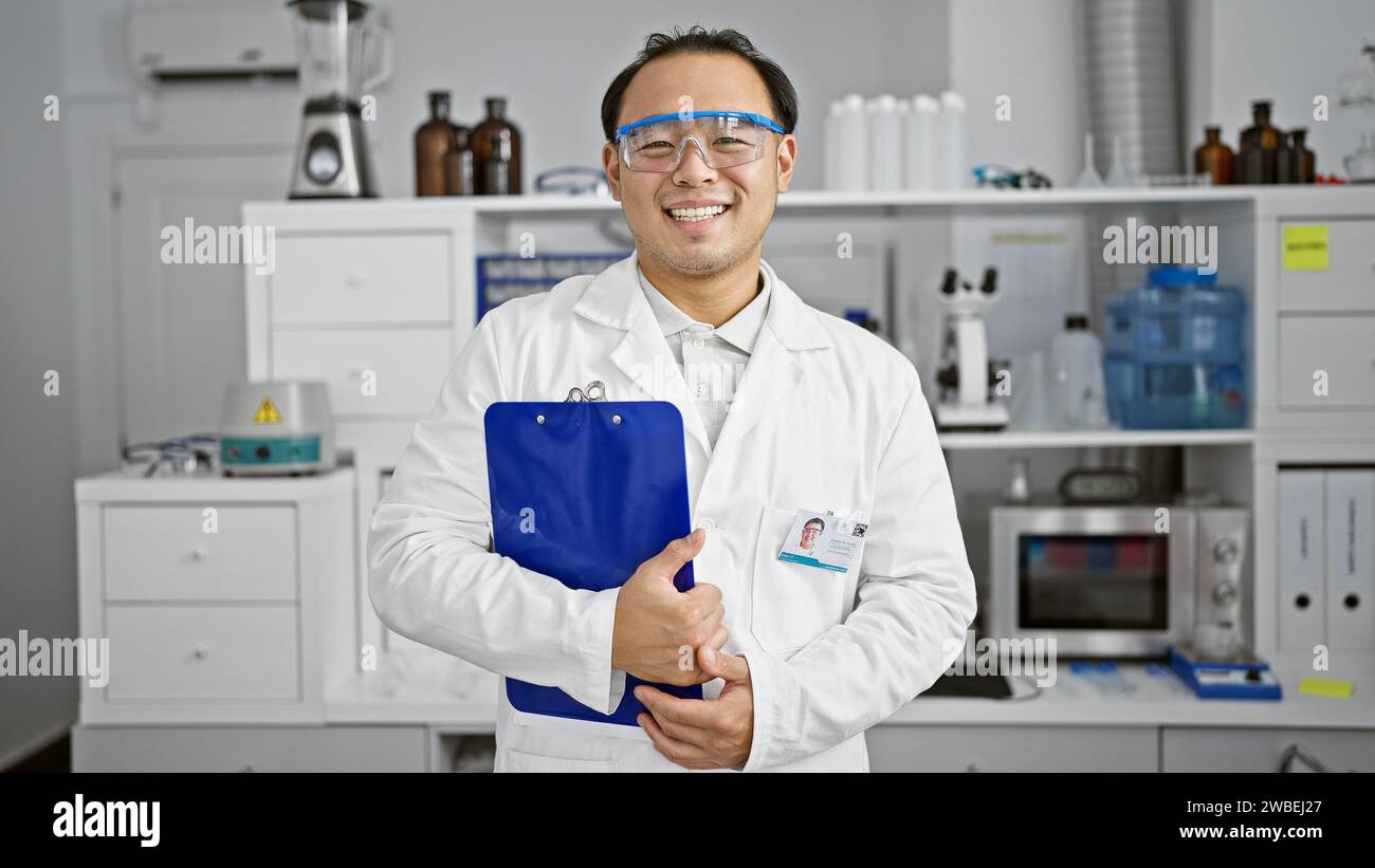 Smiling young chinese scientist, a charming professional man working ...