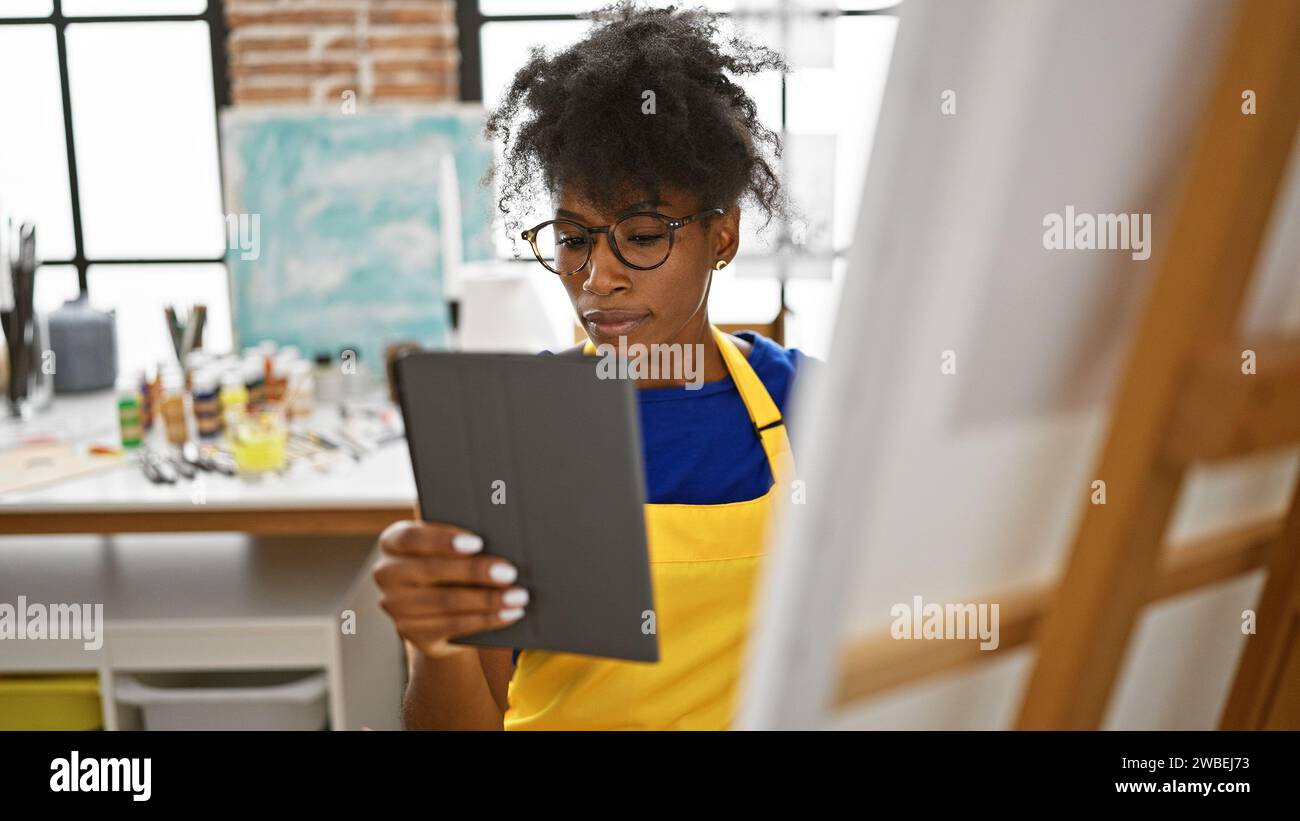 African american woman artist looking touchpad drawing at art studio ...