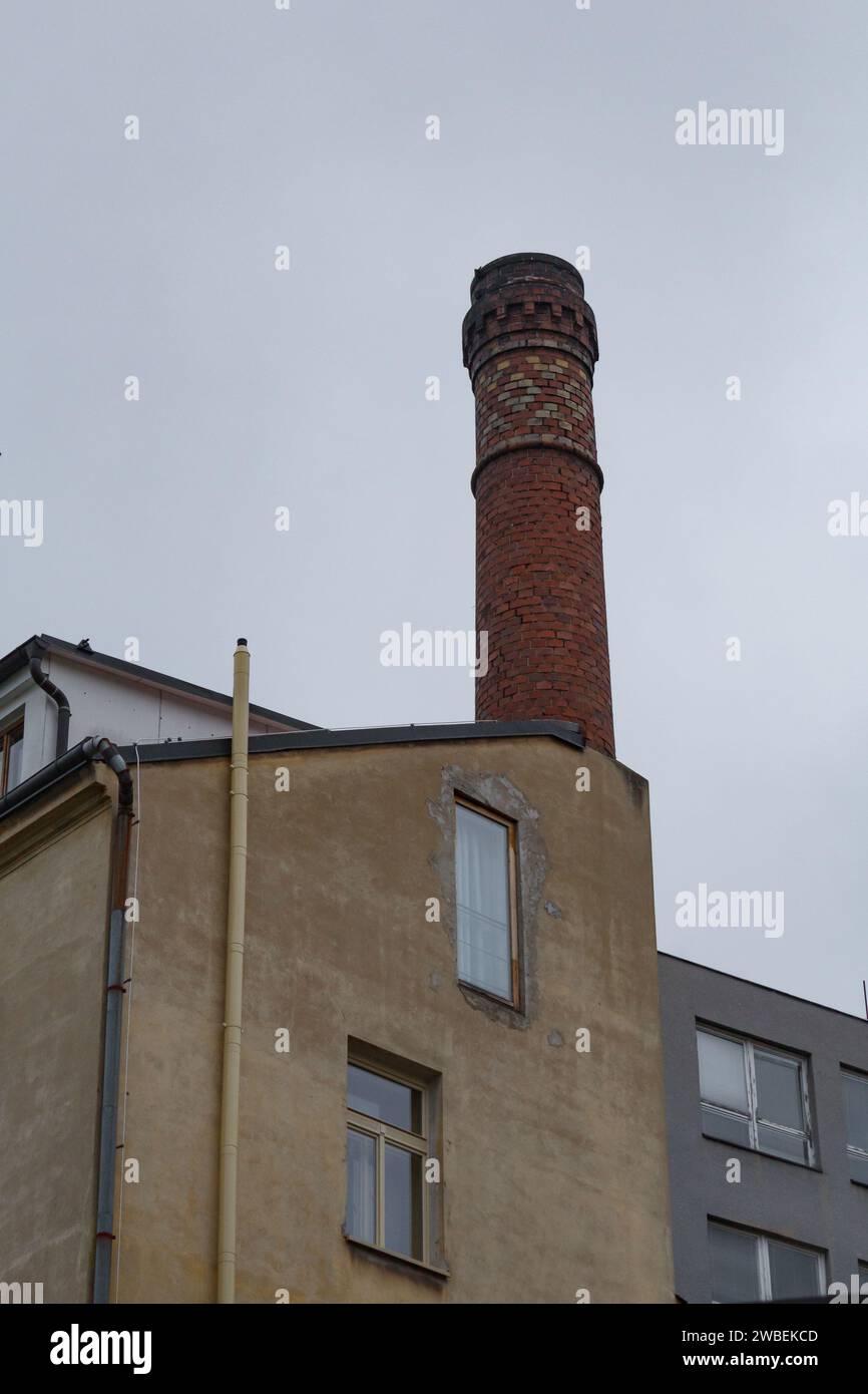 A tall chimney in a industrial zone in Prague city ona winter day in ...