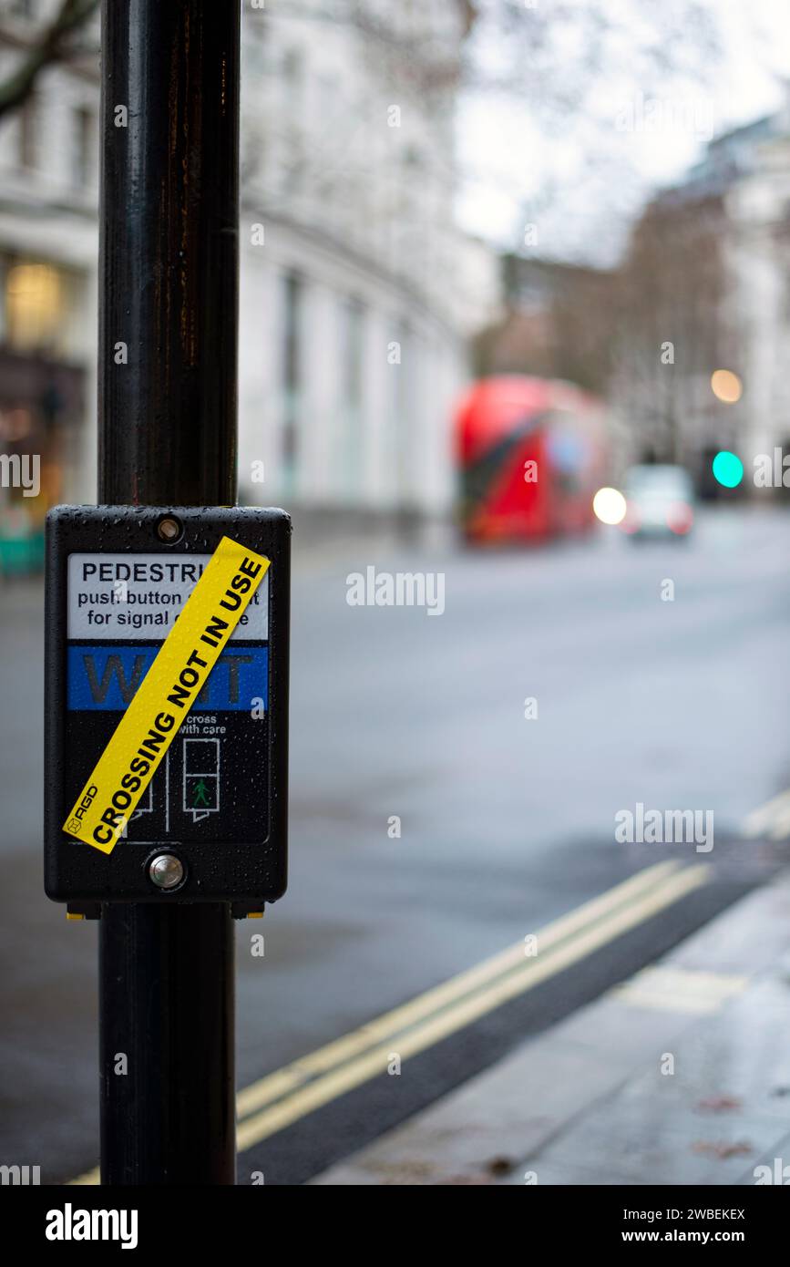 "Crossing not in use" sticker on a traffic light Stock Photo - Alamy