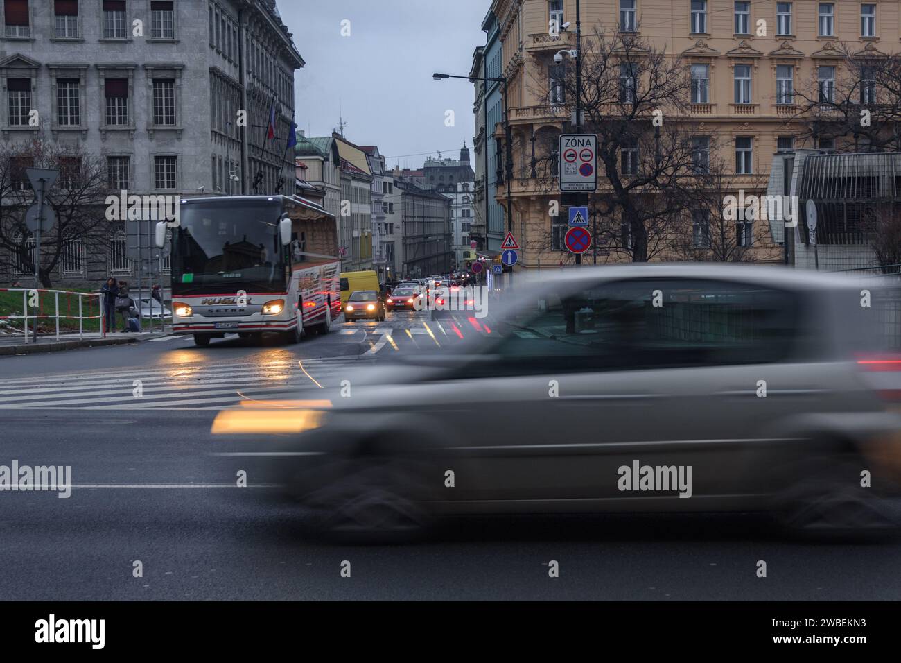 Photo of a car passing by with motion blur at high speed driving. A bus ...