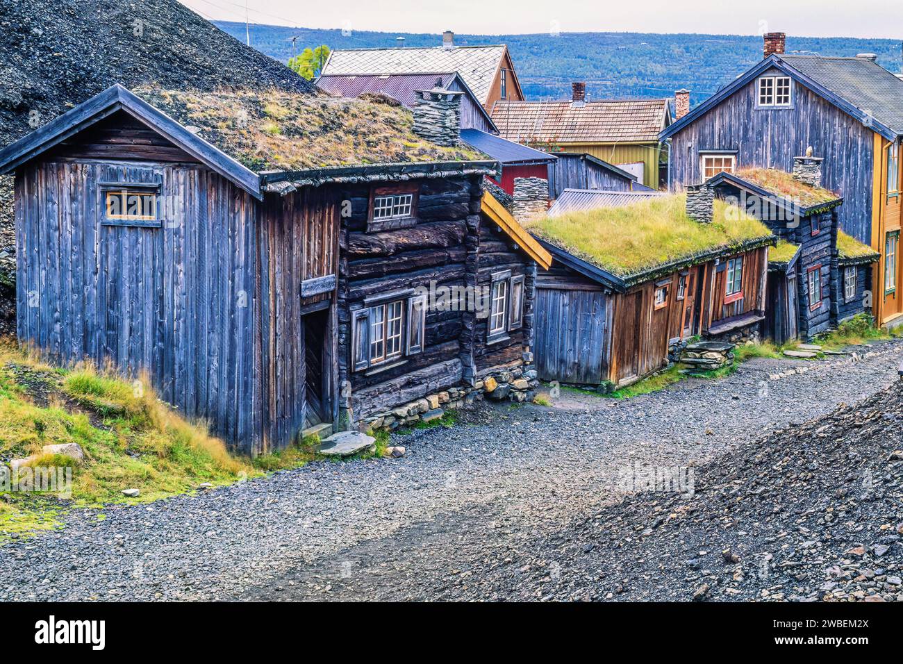 Old wooden buildings by a street in the Røros mine village in Norway ...