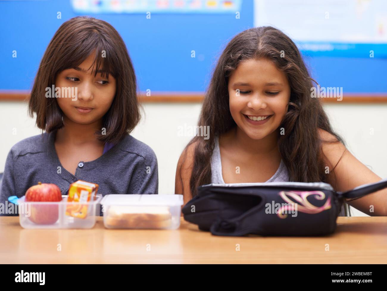 Happy kids, students and eating food in classroom at school for meal ...