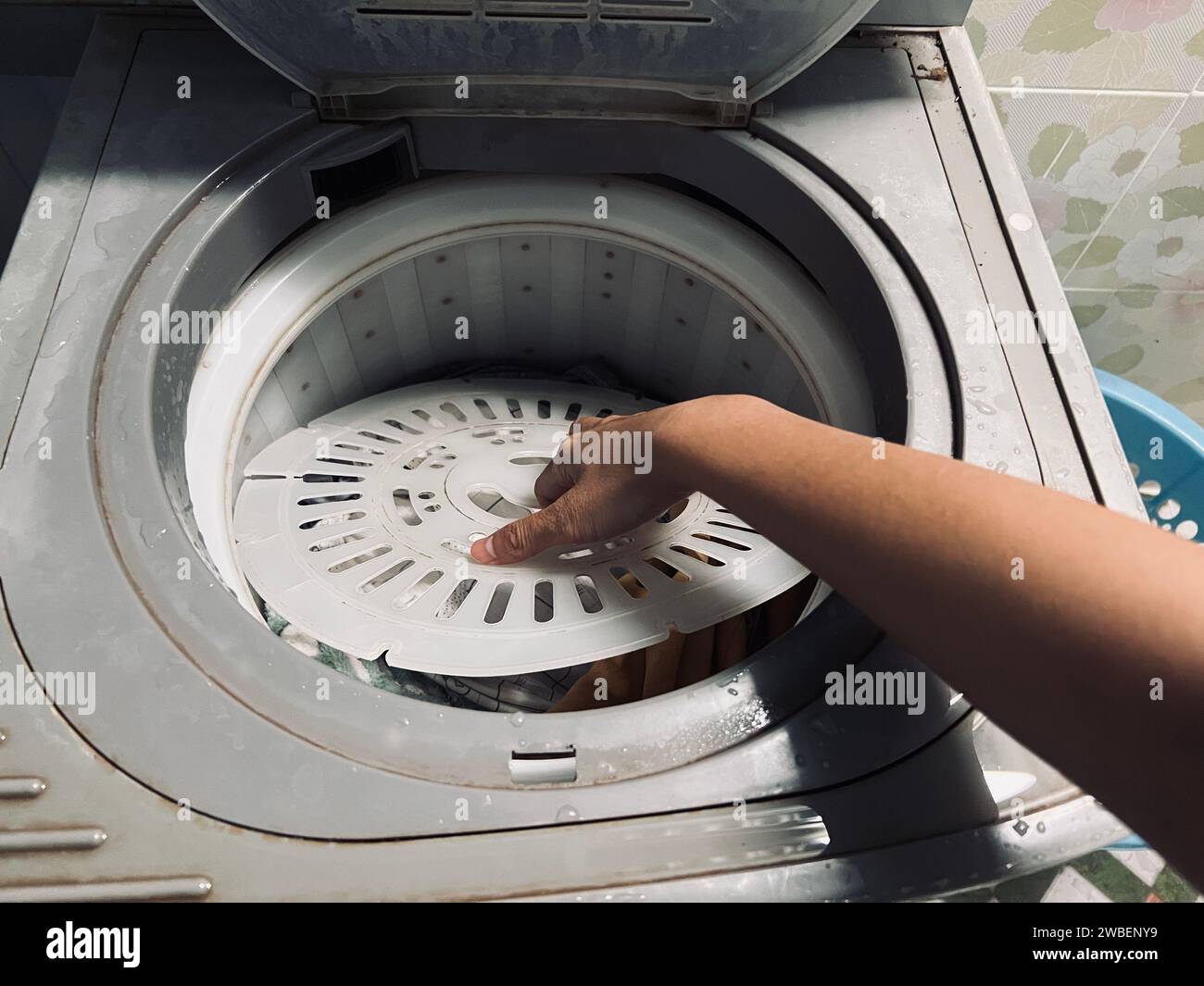 Washing clothes, spinning clothes in the dry cleaning tank in the old ...