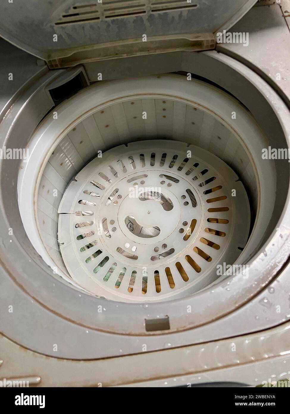 Washing clothes, spinning clothes in the dry cleaning tank in the old ...