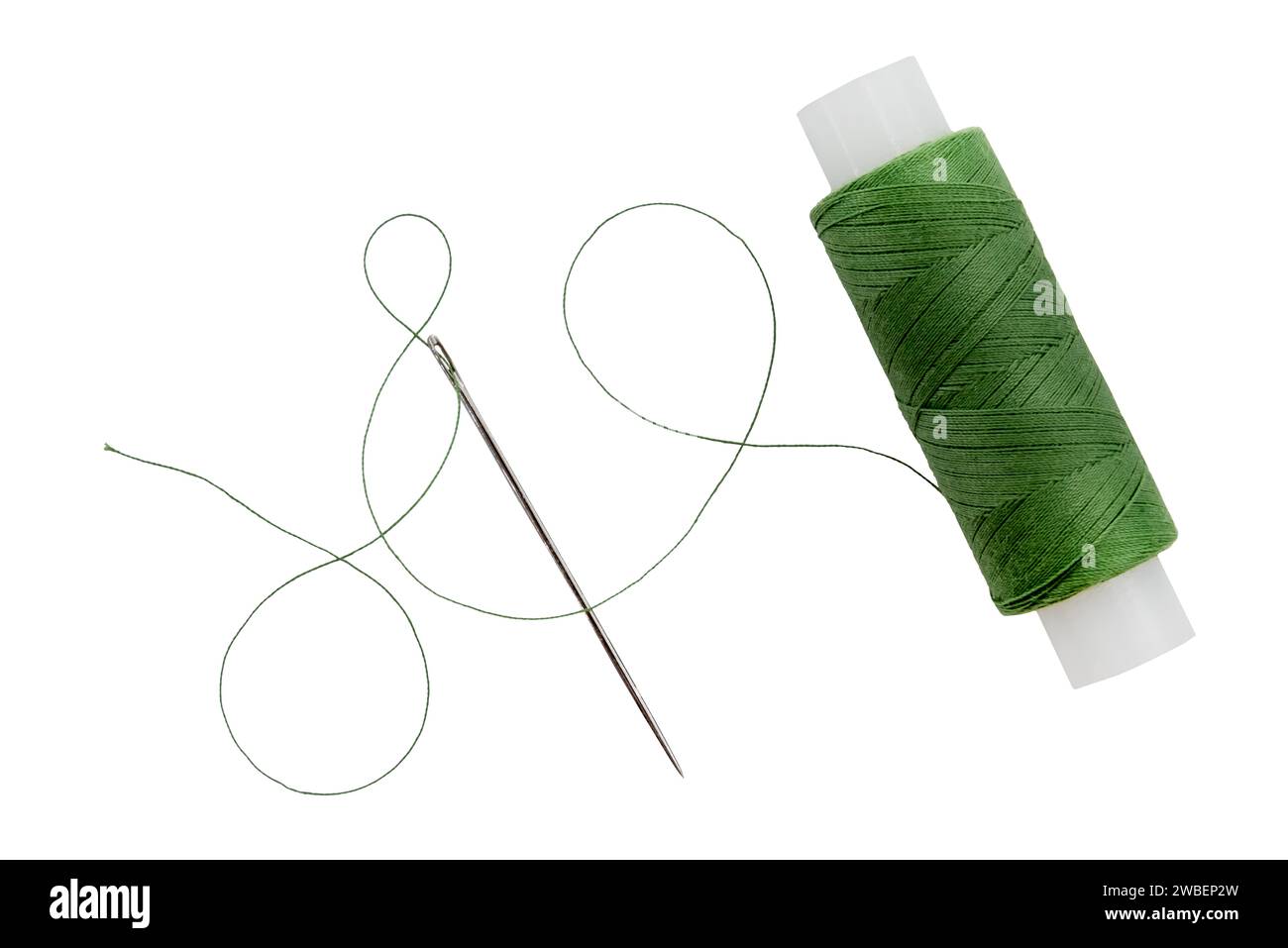 Old spool of thread and needle on a white background. Sewing ...