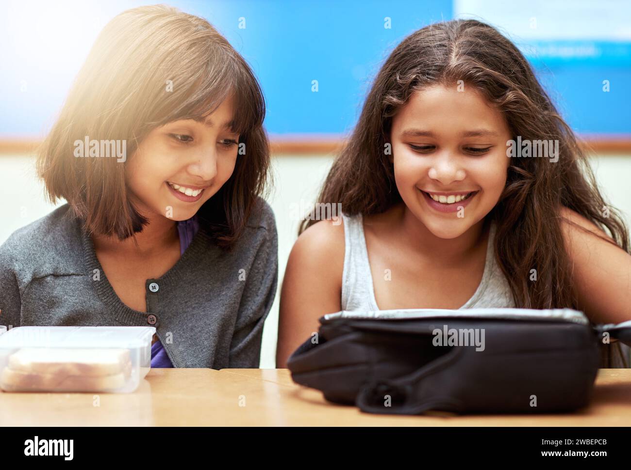 Happy children, students and eating food in classroom at school for ...