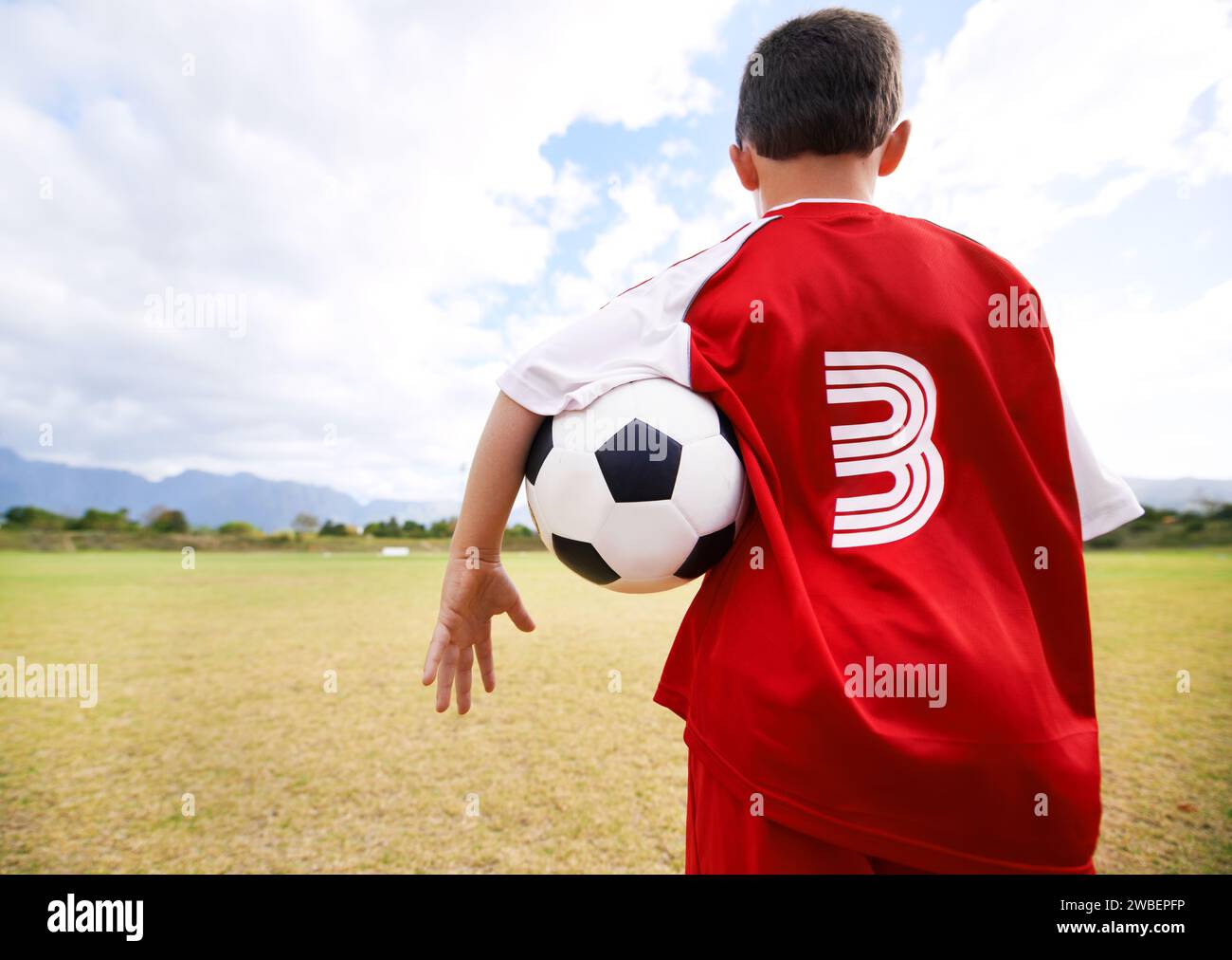 Child, back view and soccer player on field for practice, workout and ...