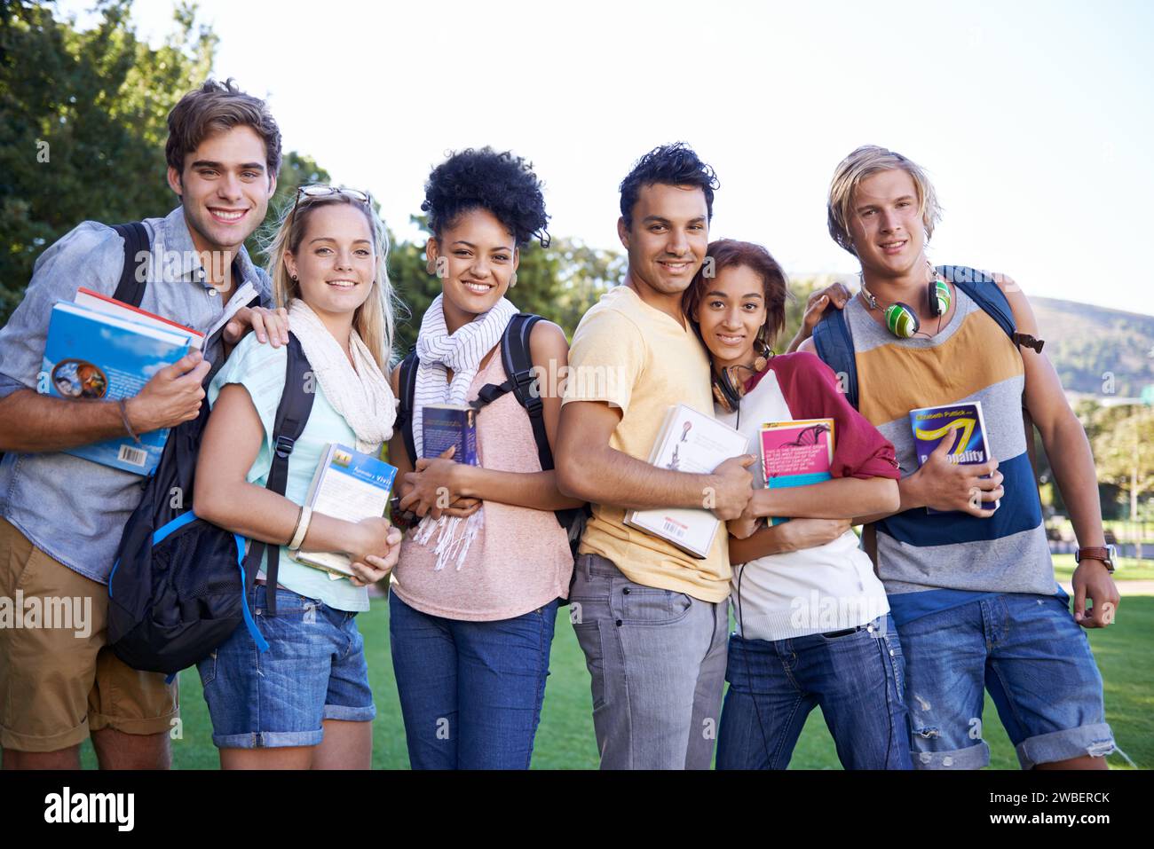 Books, portrait or students in park at college, campus or together with ...
