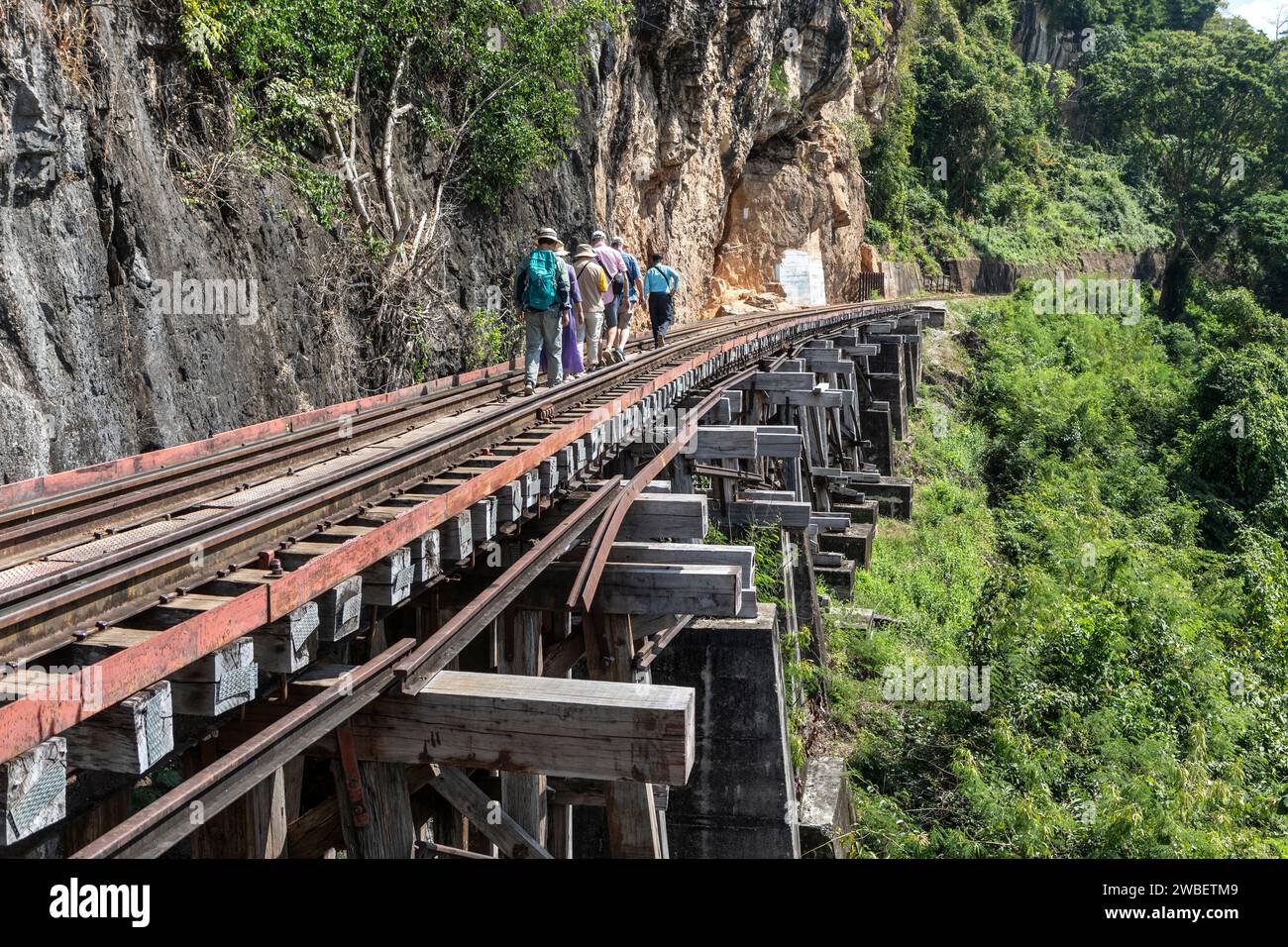 Tourists walking on the wooden death railway bridge at Tham Krasae ...