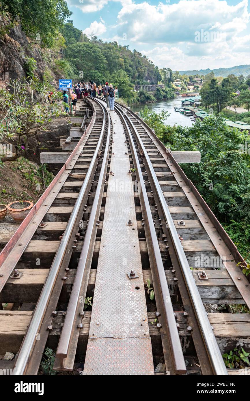 Tourists walking on the wooden death railway bridge at Tham Krasae ...