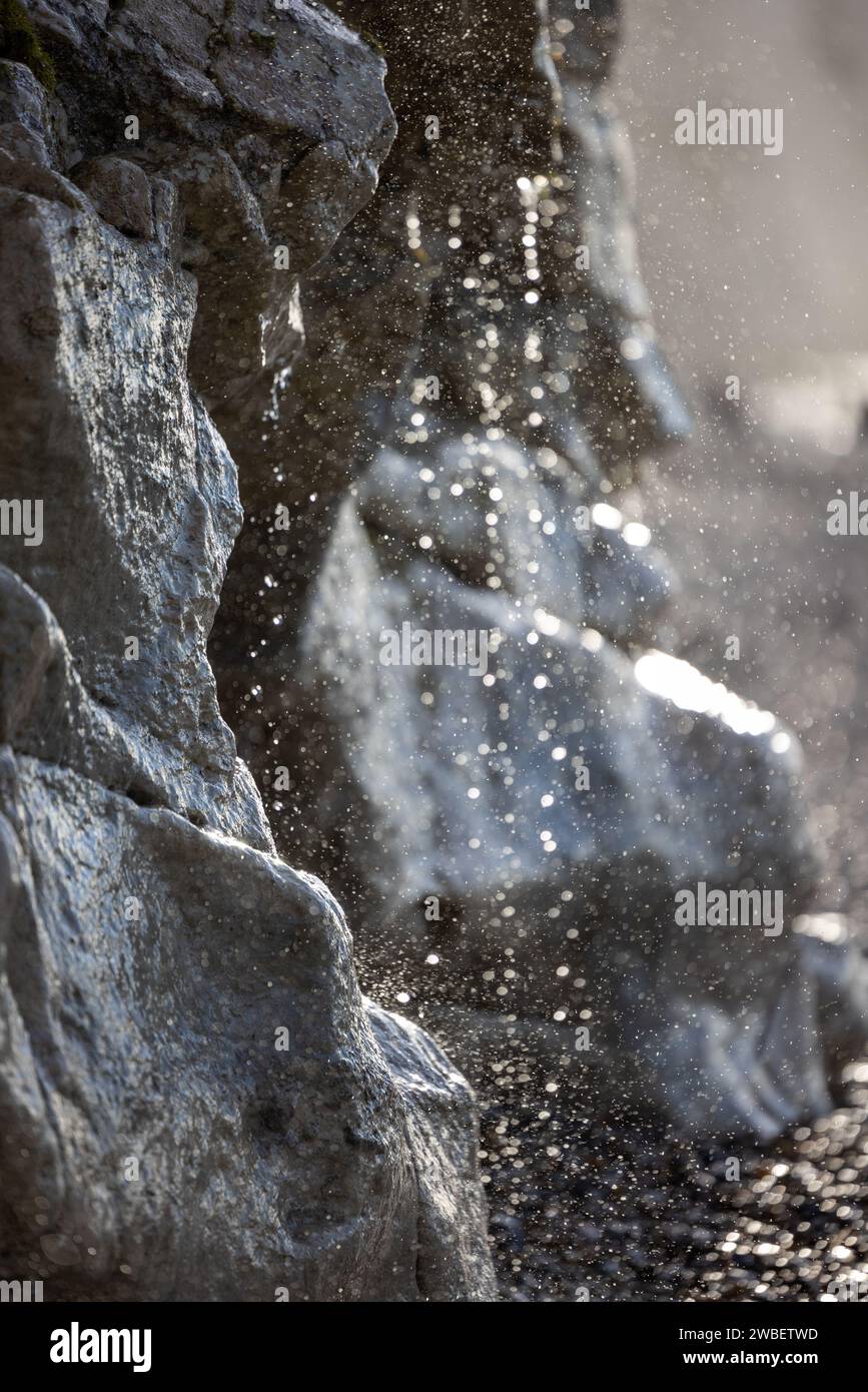 This image intimately focuses on the moment where water cascades down a ...