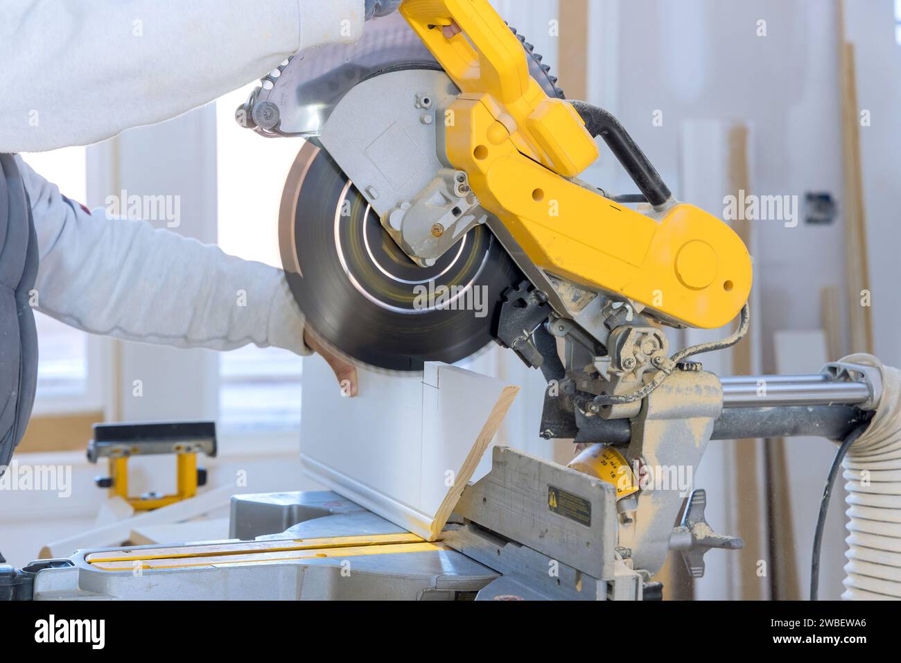 To cut wooden base moldings of house improvement project, use chop saw ...