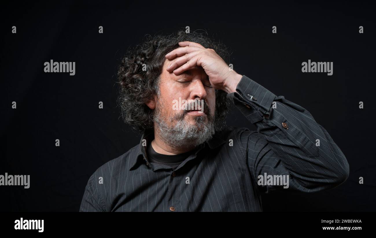Portrait of latin man with white beard and black curly hair with ...