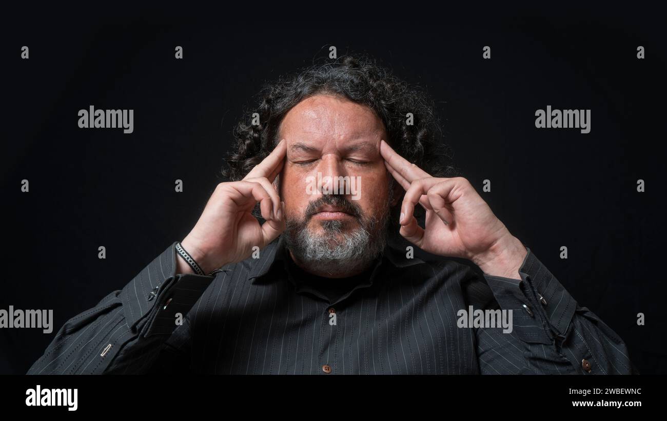 Portrait of latin man with white beard and black curly hair with ...