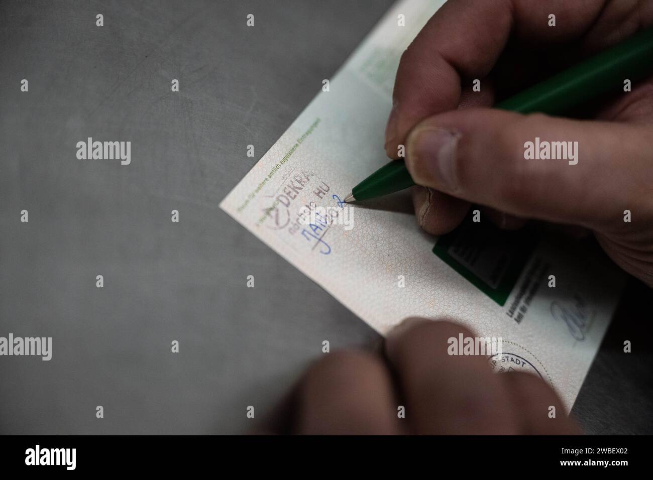 Stuttgart, Germany. 10th Jan, 2024. An employee of the testing ...