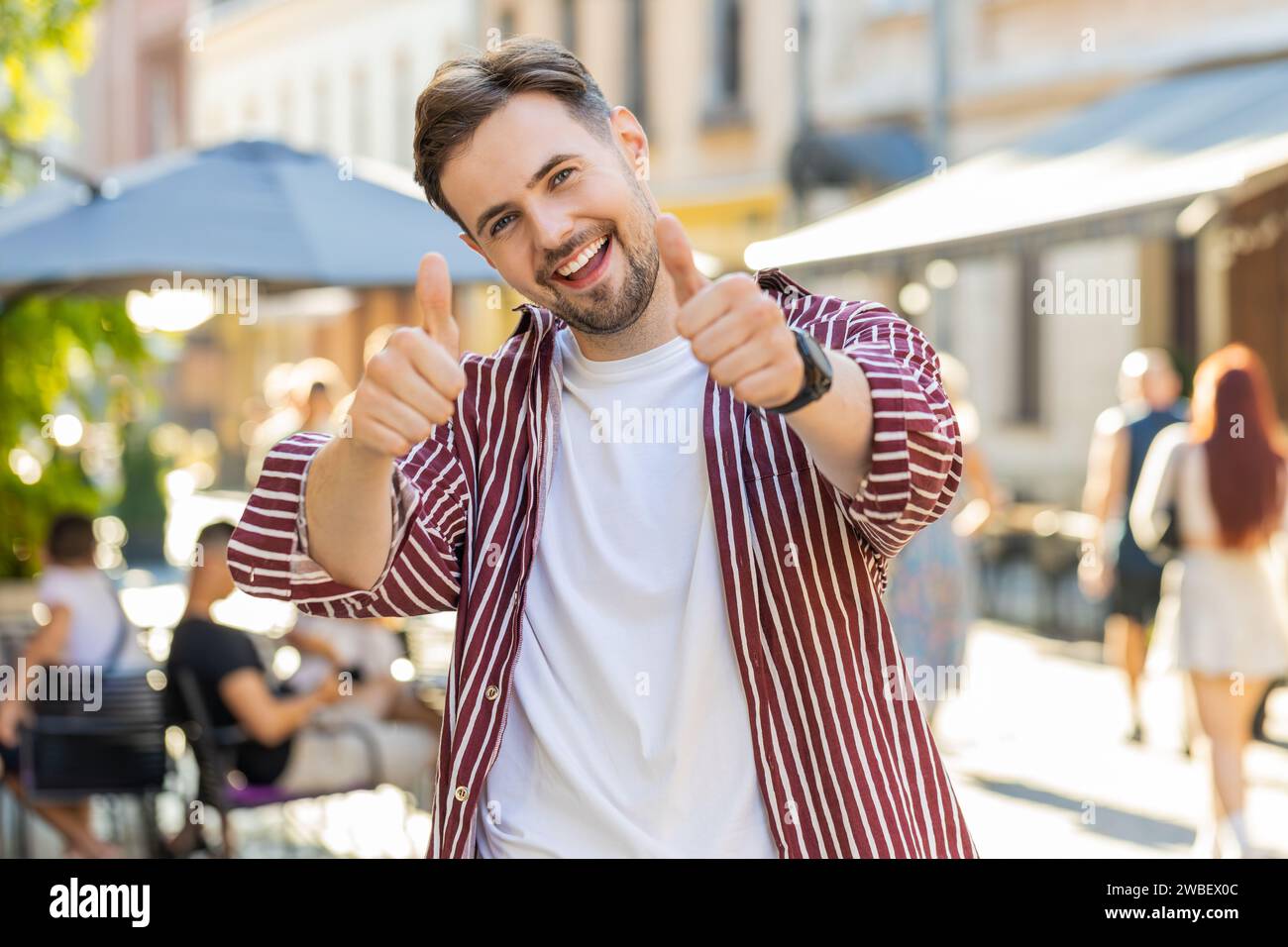 Like. Happy brunette bearded man looking approvingly at camera showing ...
