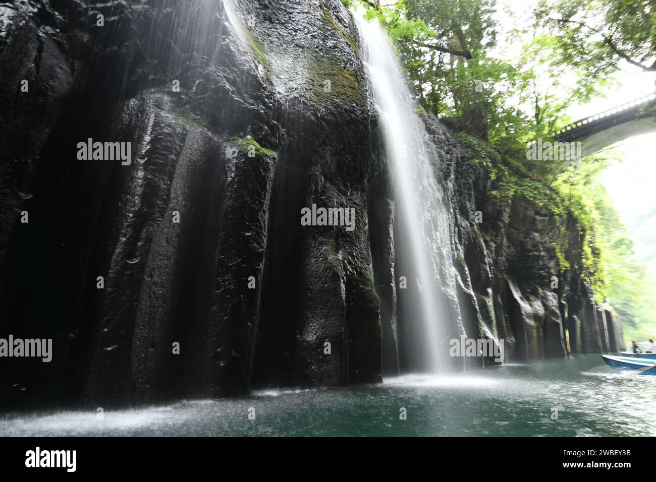 A scenic landscape featuring a majestic waterfall cascading down a ...