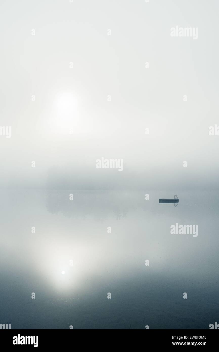 Dock floating on a lake in heavy fog Stock Photo - Alamy