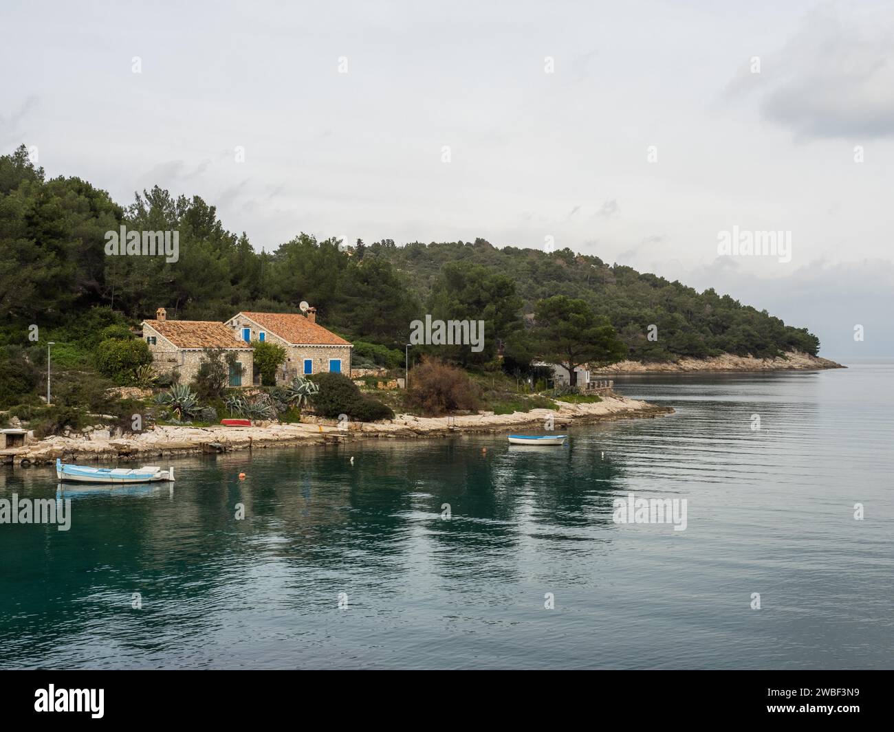 View from the promenade path to a small house by the sea, near Veli ...