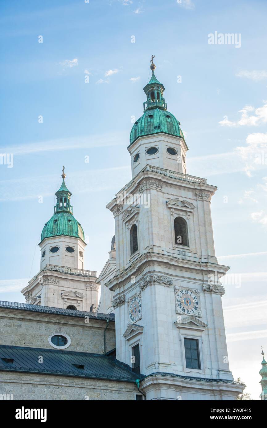 Sky rises behind two prominent church towers with detailed architecture ...