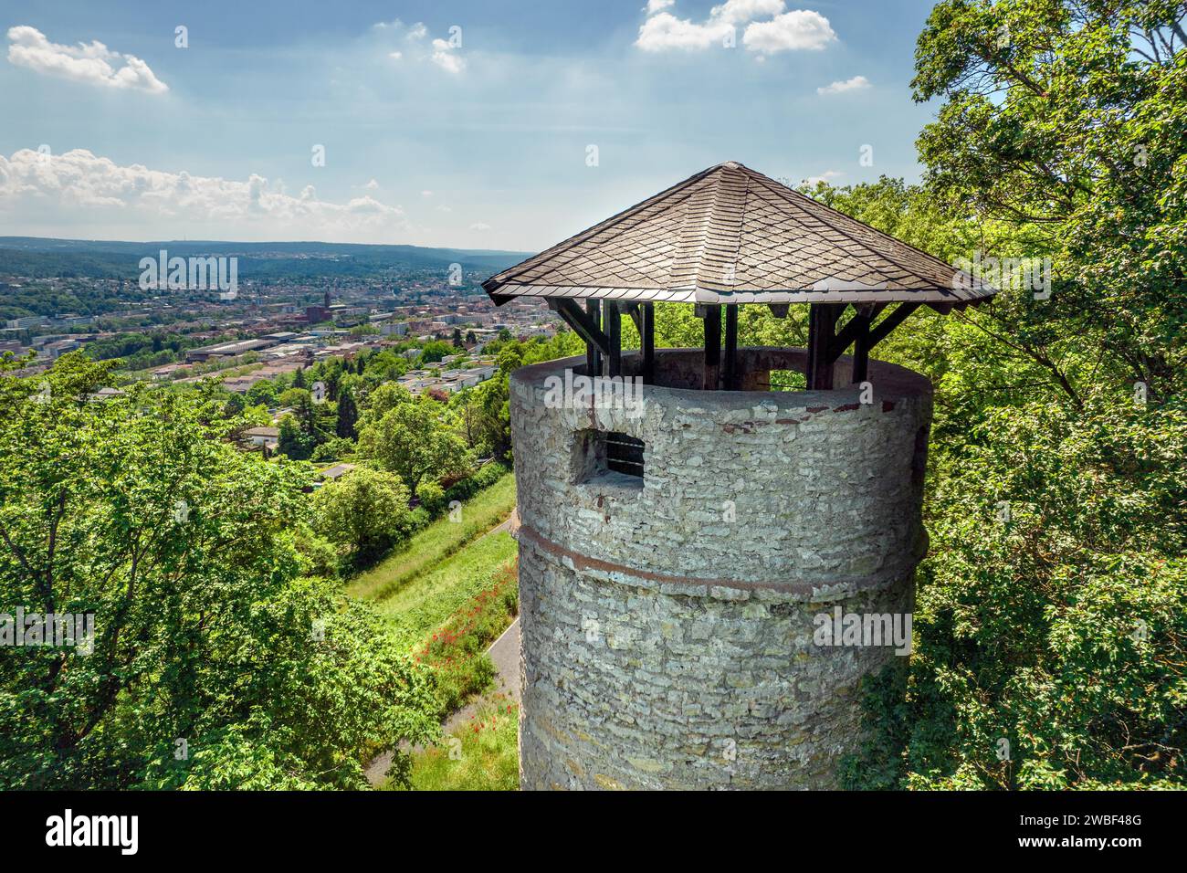 Stone observation tower surrounded by trees with a view of a landscape ...