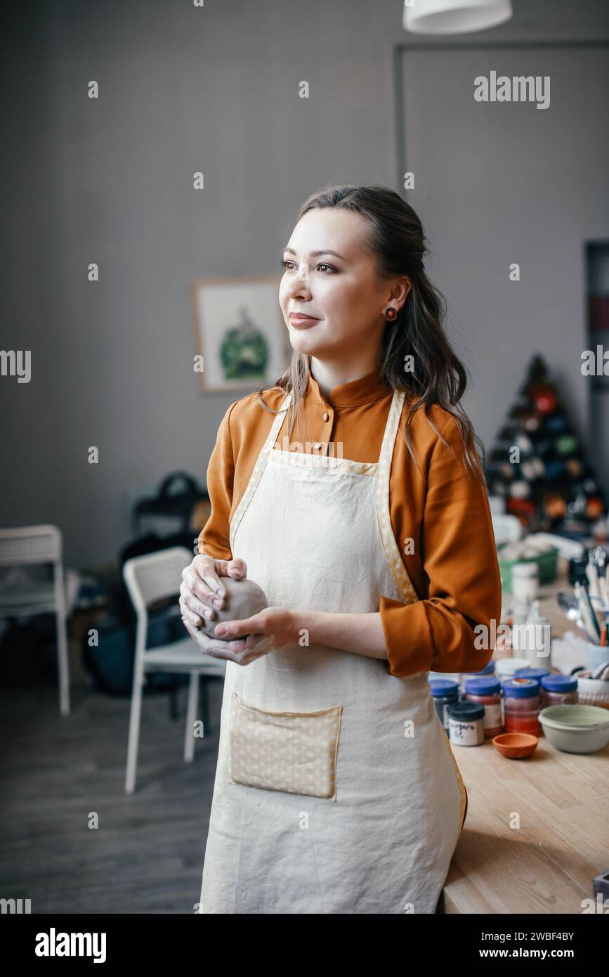 Portrait of a beautiful smiling pottery workshop leader Stock Photo - Alamy